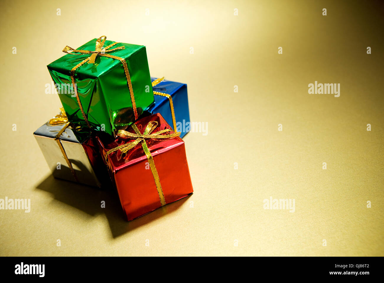 Series of miniature, colorful gift boxes, some on colored backgrounds ...