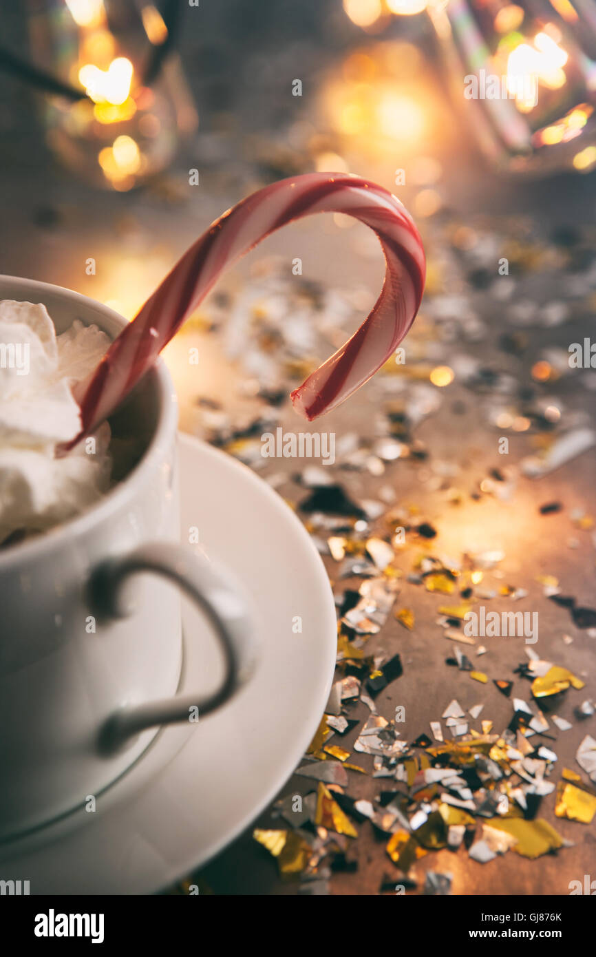 Holiday: Candy Cane In Mug Of Cocoa With Light Bulbs Behind Stock Photo ...
