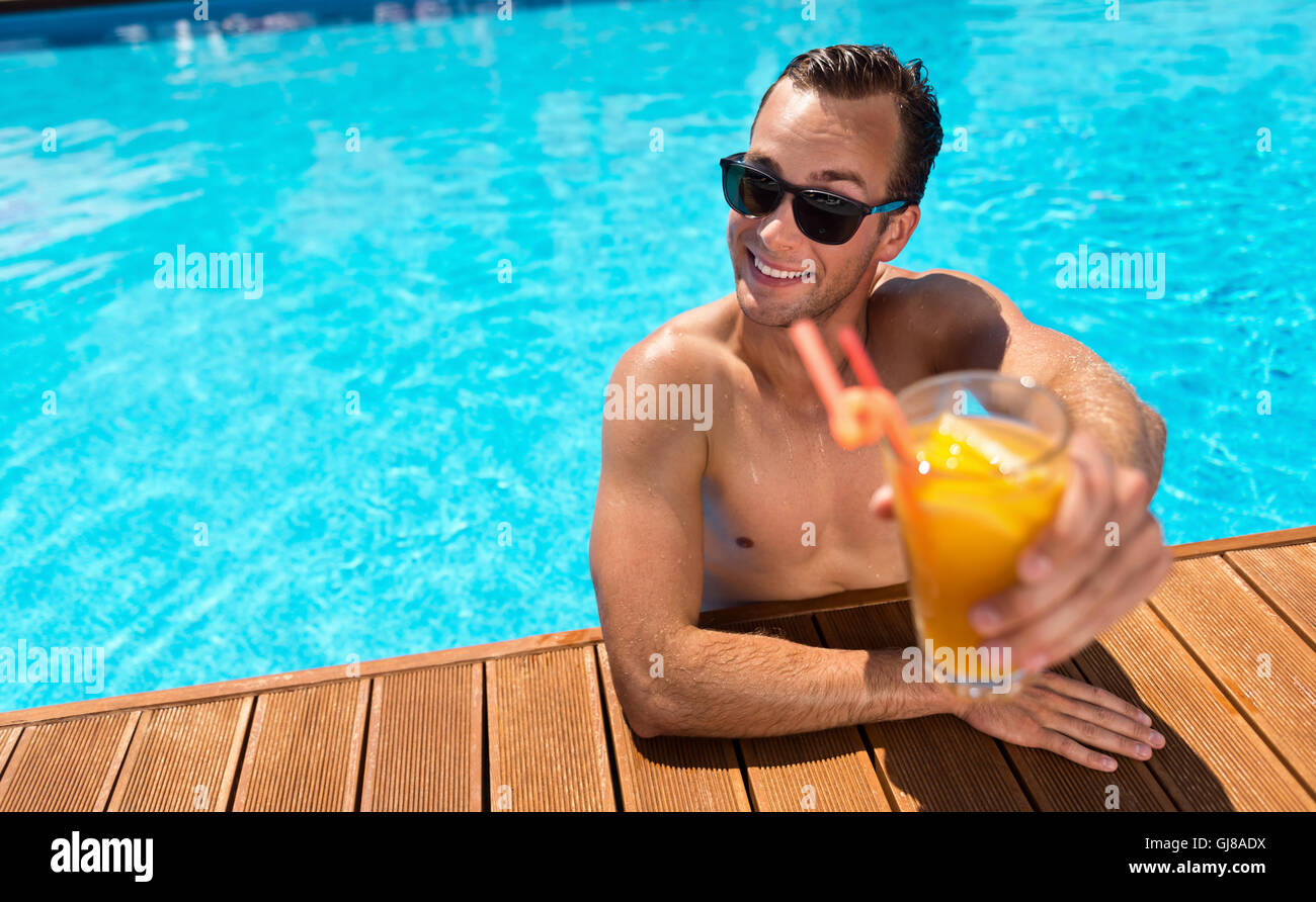 Delighted man relaxing in the swimming pool Stock Photo - Alamy