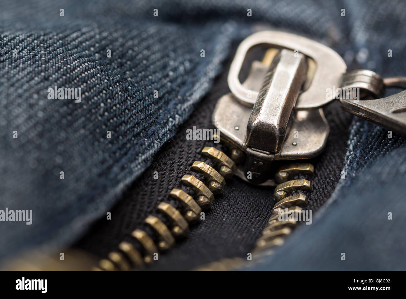 Close up and detailed shot of a metallic zip on denim Stock Photo - Alamy