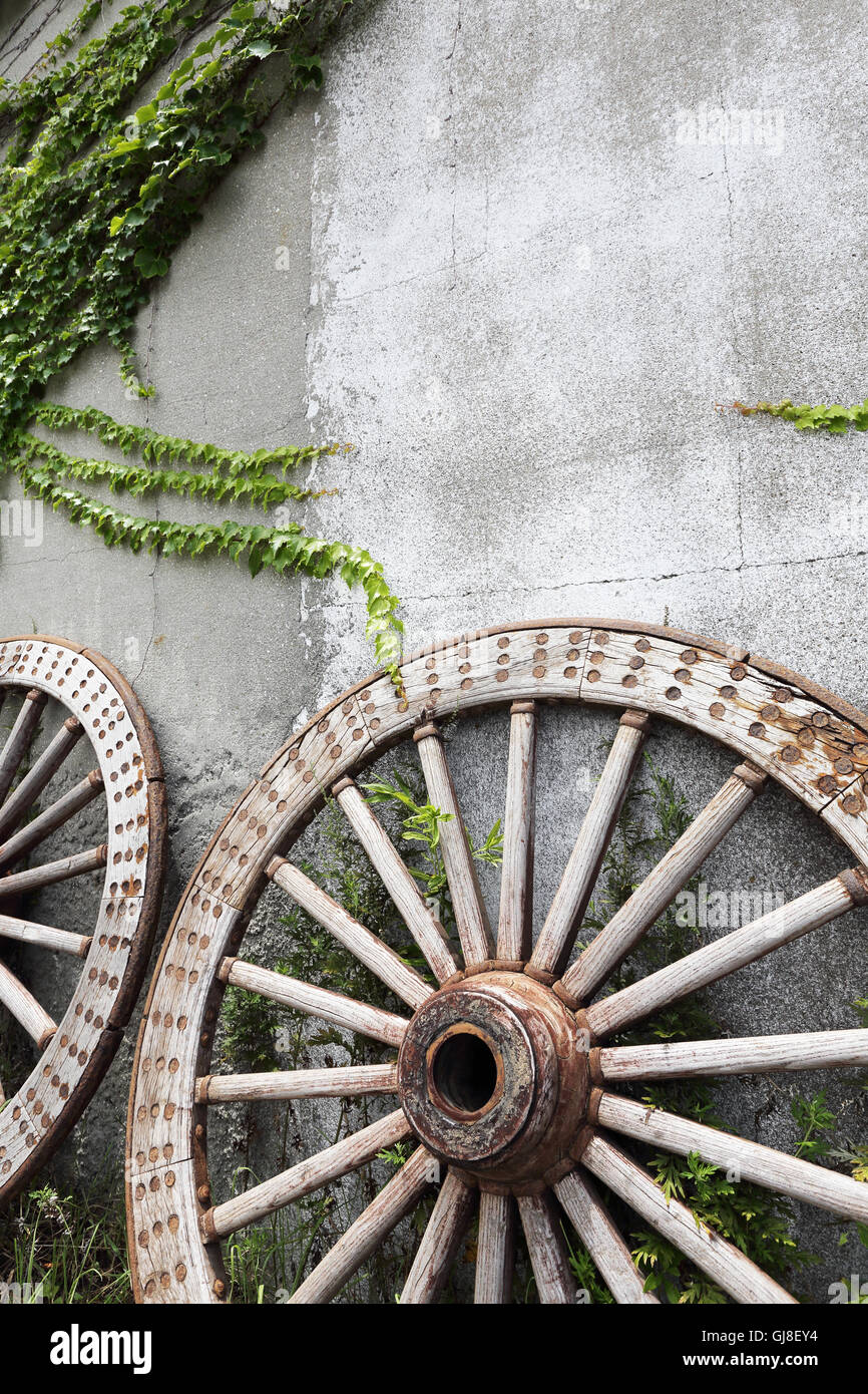 Wooden wheel on the background of an old brick wall Stock Photo - Alamy