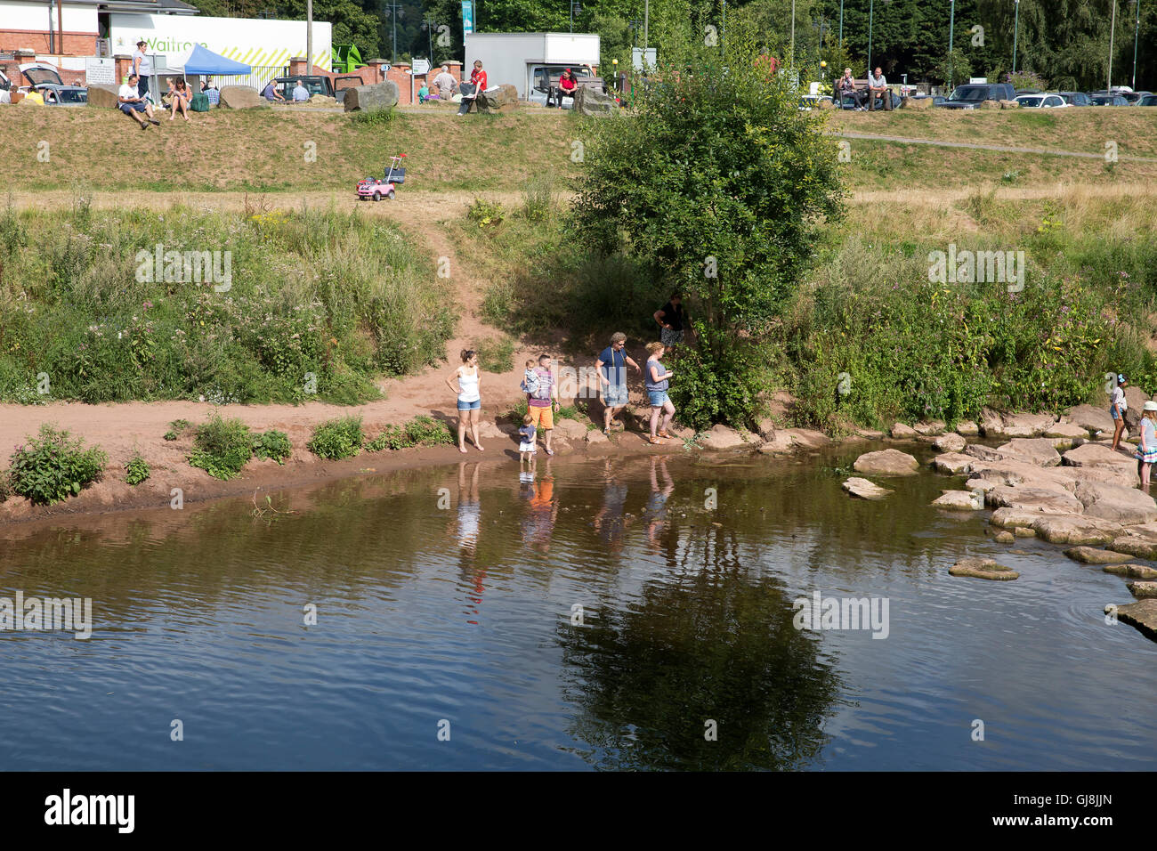 Monmouth,UK,13th August 2016,Families with children paddle in the river ...