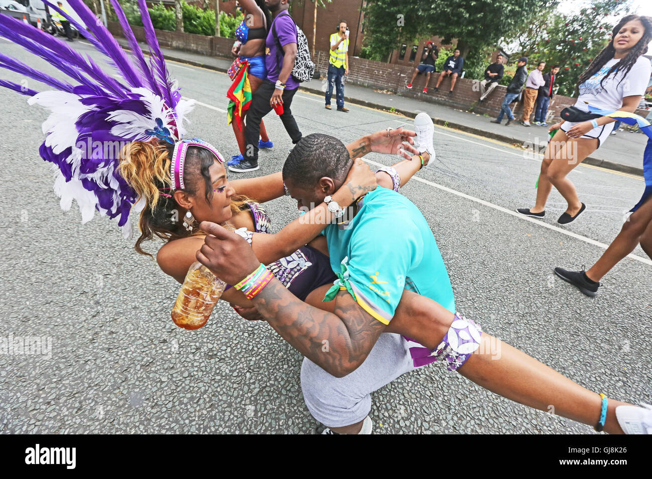 Manchester, UK. 13th Aug, 2016. A couple dance on the street in Moss ...