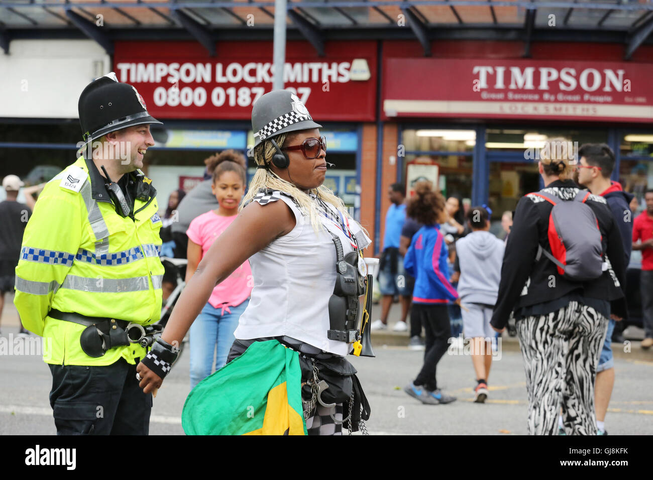 Manchester, UK. 13th Aug, 2016. A Policeman laughs at carnival goers ...