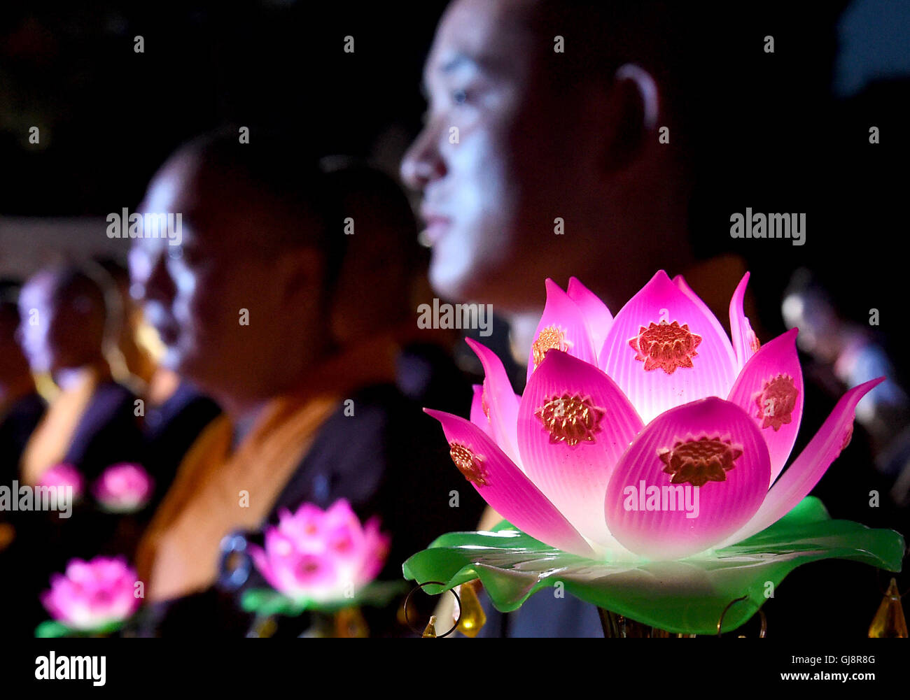 Zhengzhou, China's Henan Province. 13th Aug, 2016. Monks carrying lotus ...