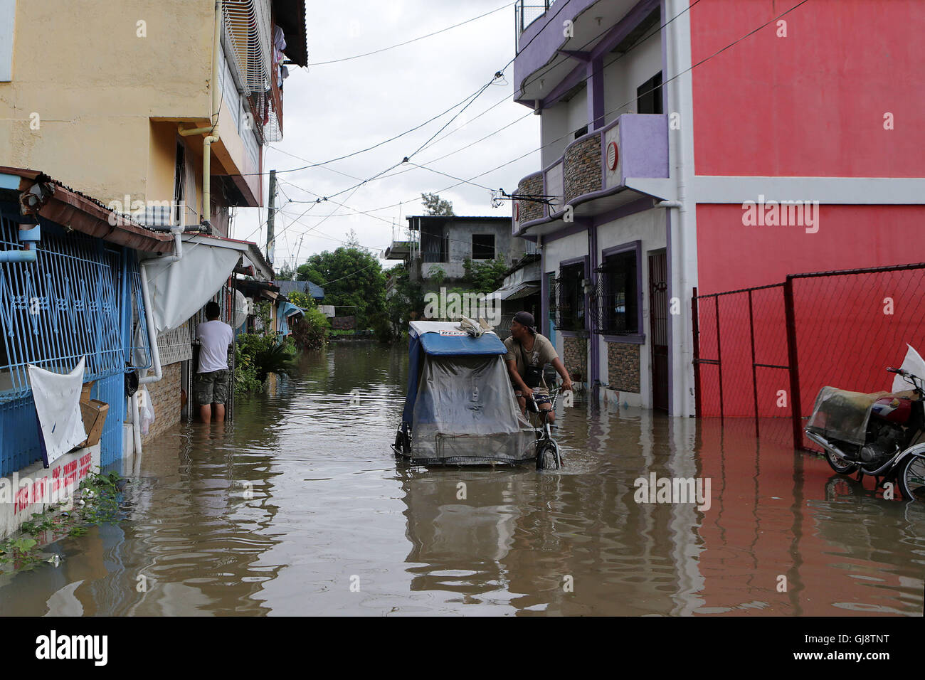 Bulacan, Philippines. 14th Aug, 2016. Residents wade through the ...