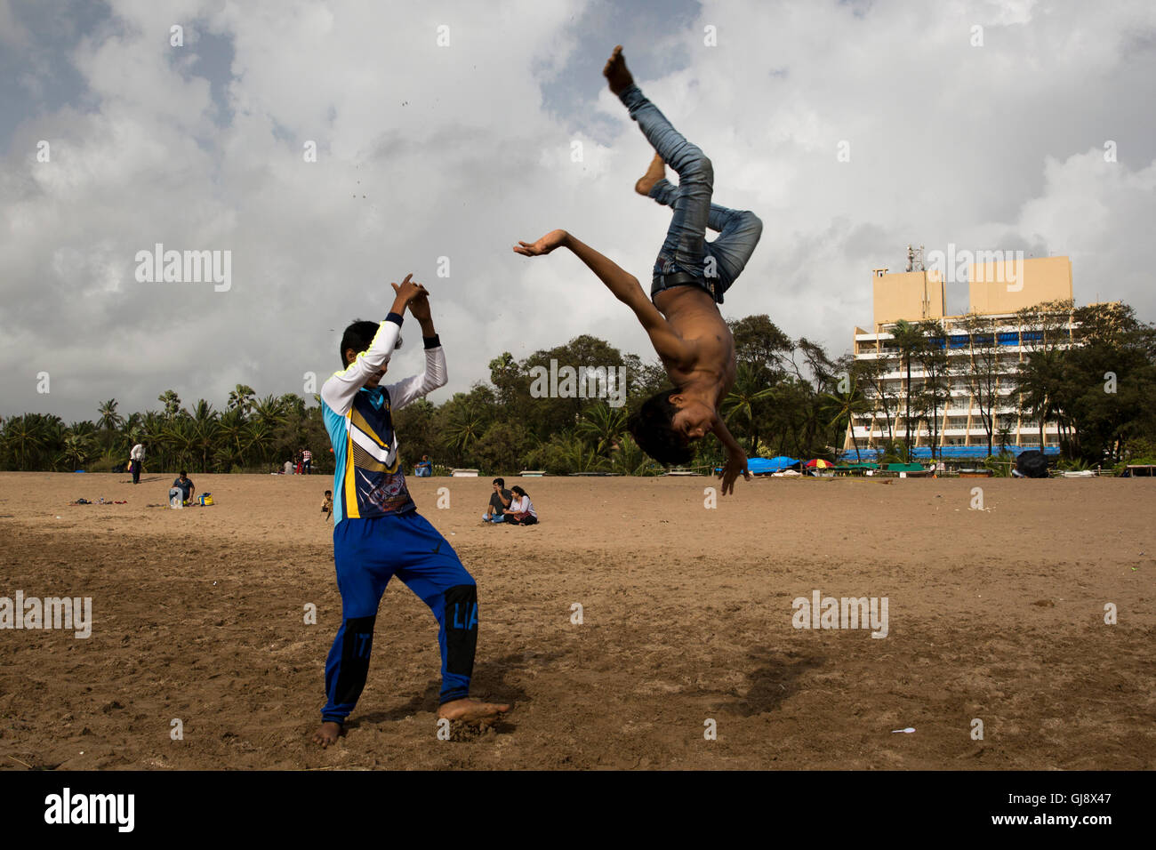 Mumbai, India. 14th August, 2016. Young indian men practicing backflips ...