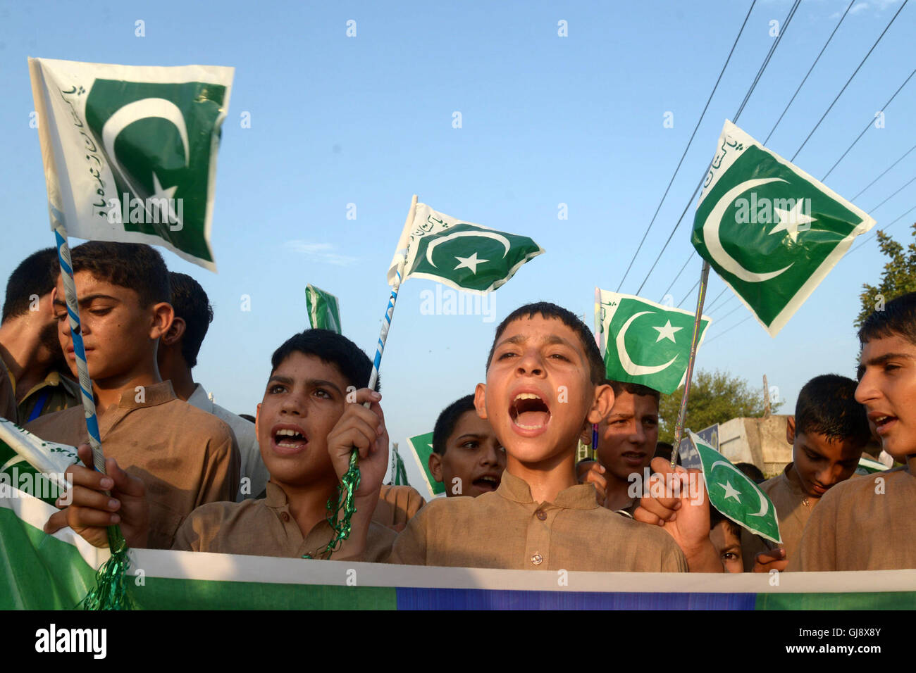 Peshawar. 14th Aug, 2016. Pakistani children wave national flags during ...