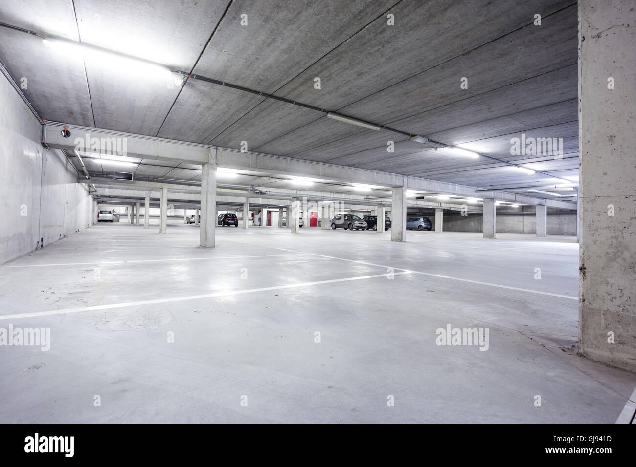 Underground park of a mall with columns and ventilation ducts Stock ...