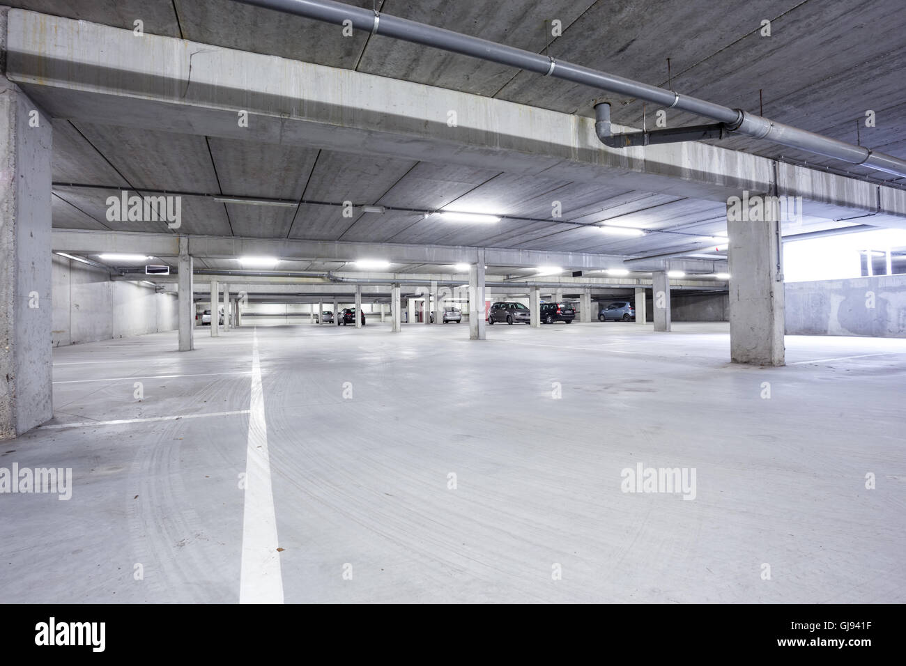 Underground park of a mall with columns and ventilation ducts Stock ...