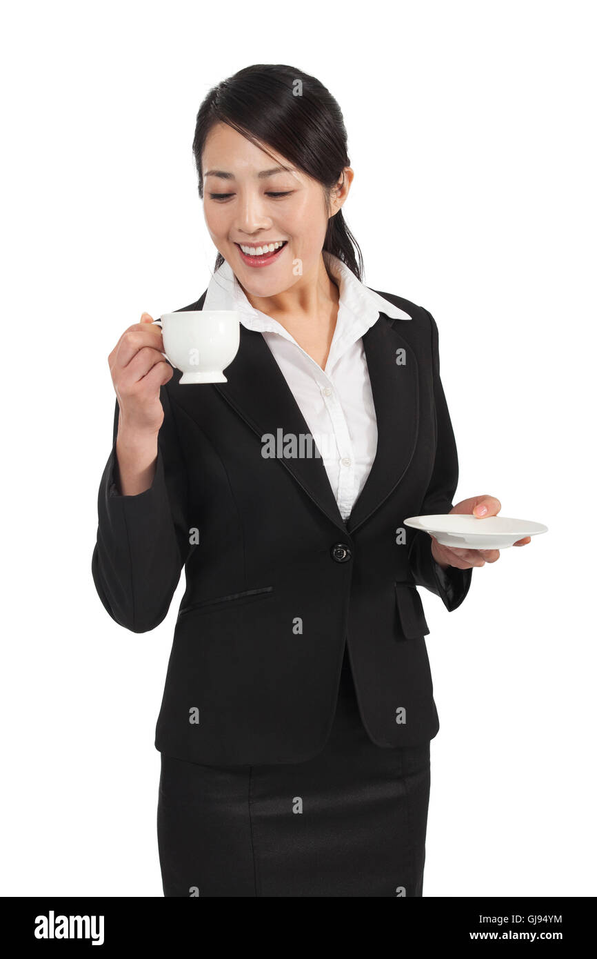 Studio shot Business lady drinking coffee Stock Photo - Alamy