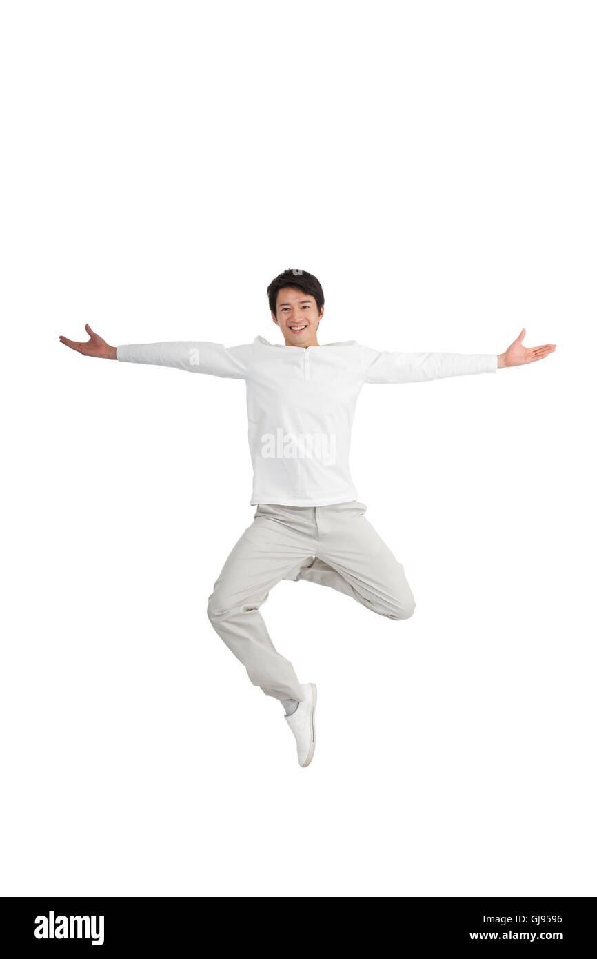 Studio shot casual men jump Stock Photo - Alamy