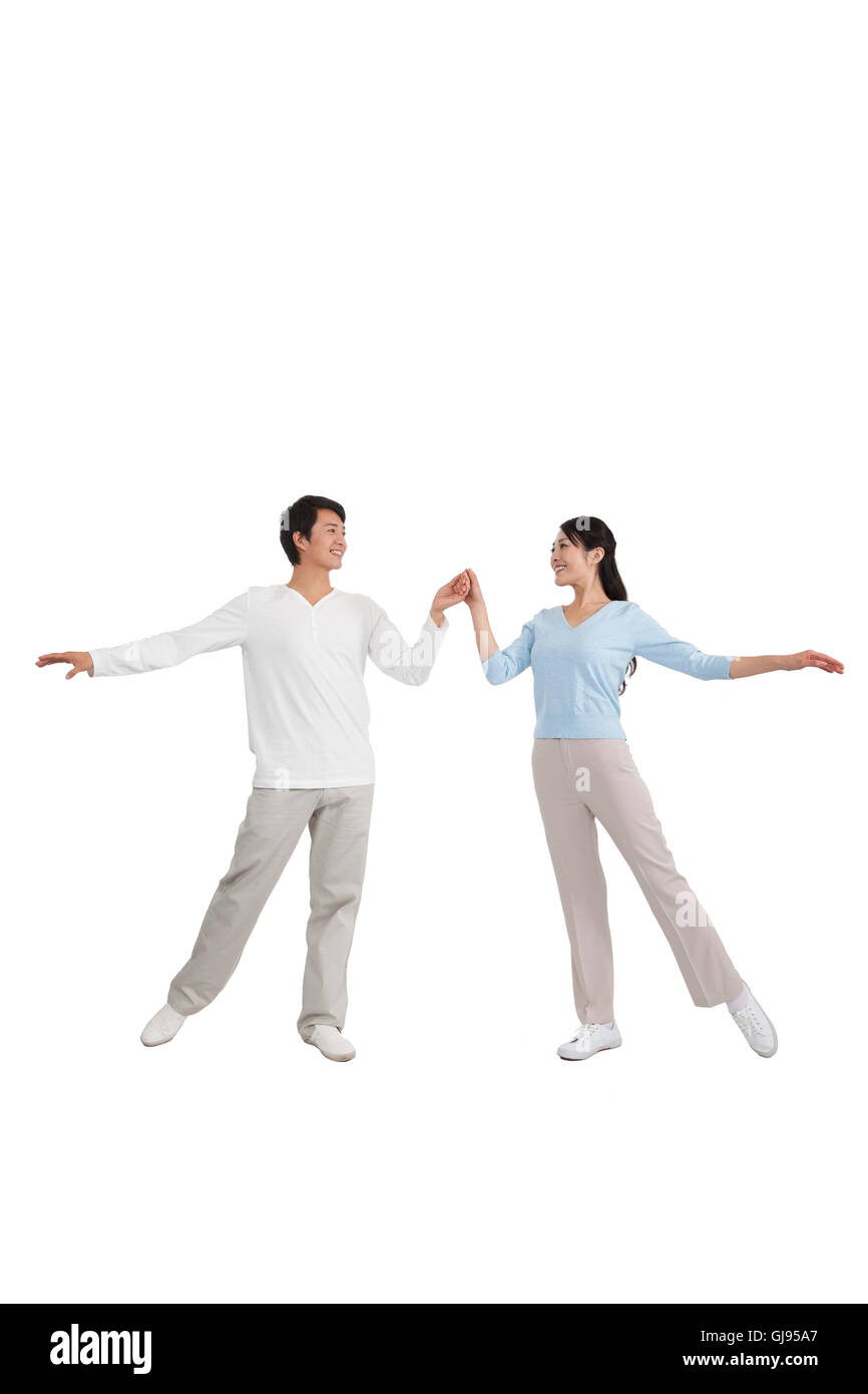 Studio shot casual couple dancing Stock Photo - Alamy
