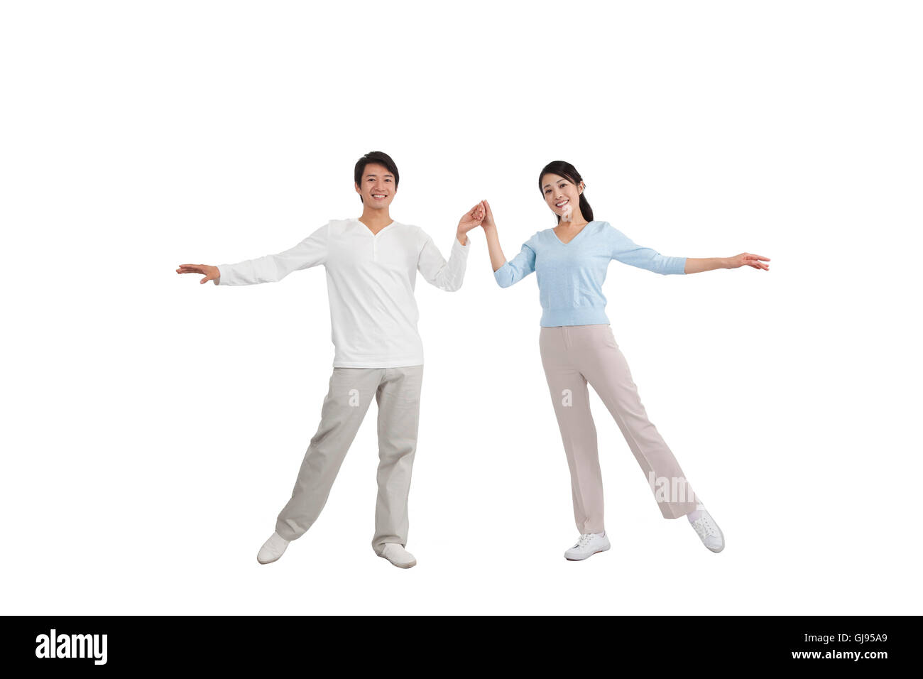 Studio shot casual couple dancing Stock Photo - Alamy