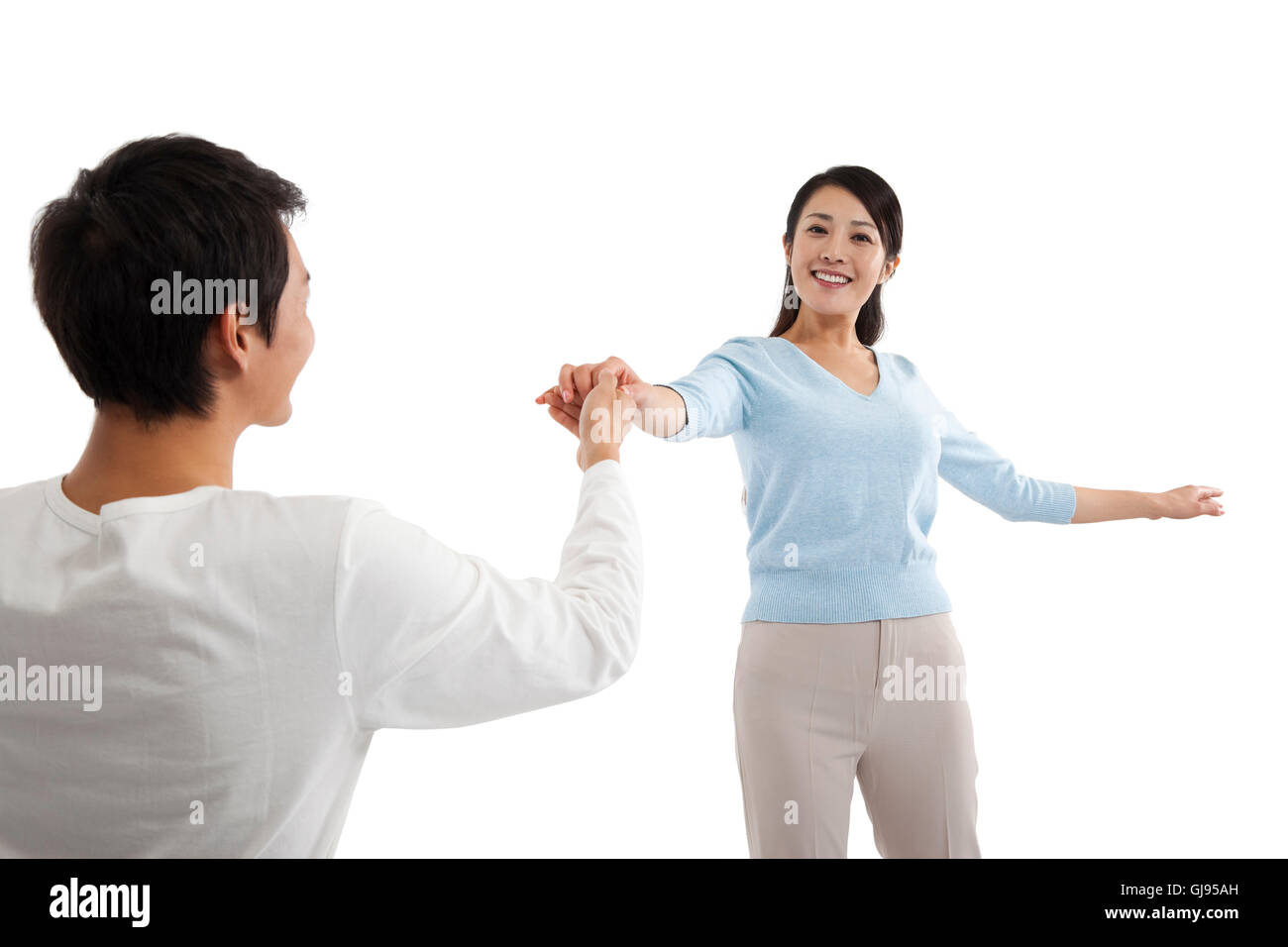 Studio shot casual couple dancing Stock Photo - Alamy
