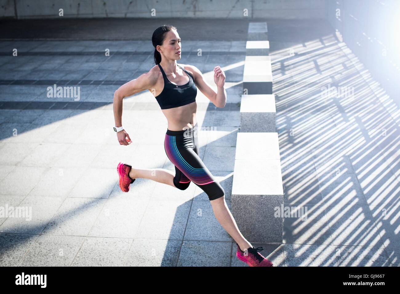 Woman running across concrete hi-res stock photography and images - Alamy