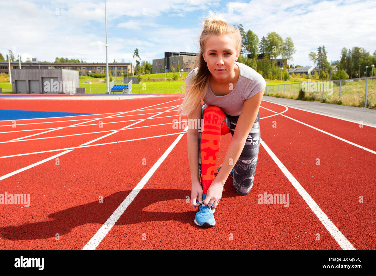 Woman sitting on running track hi-res stock photography and images - Alamy