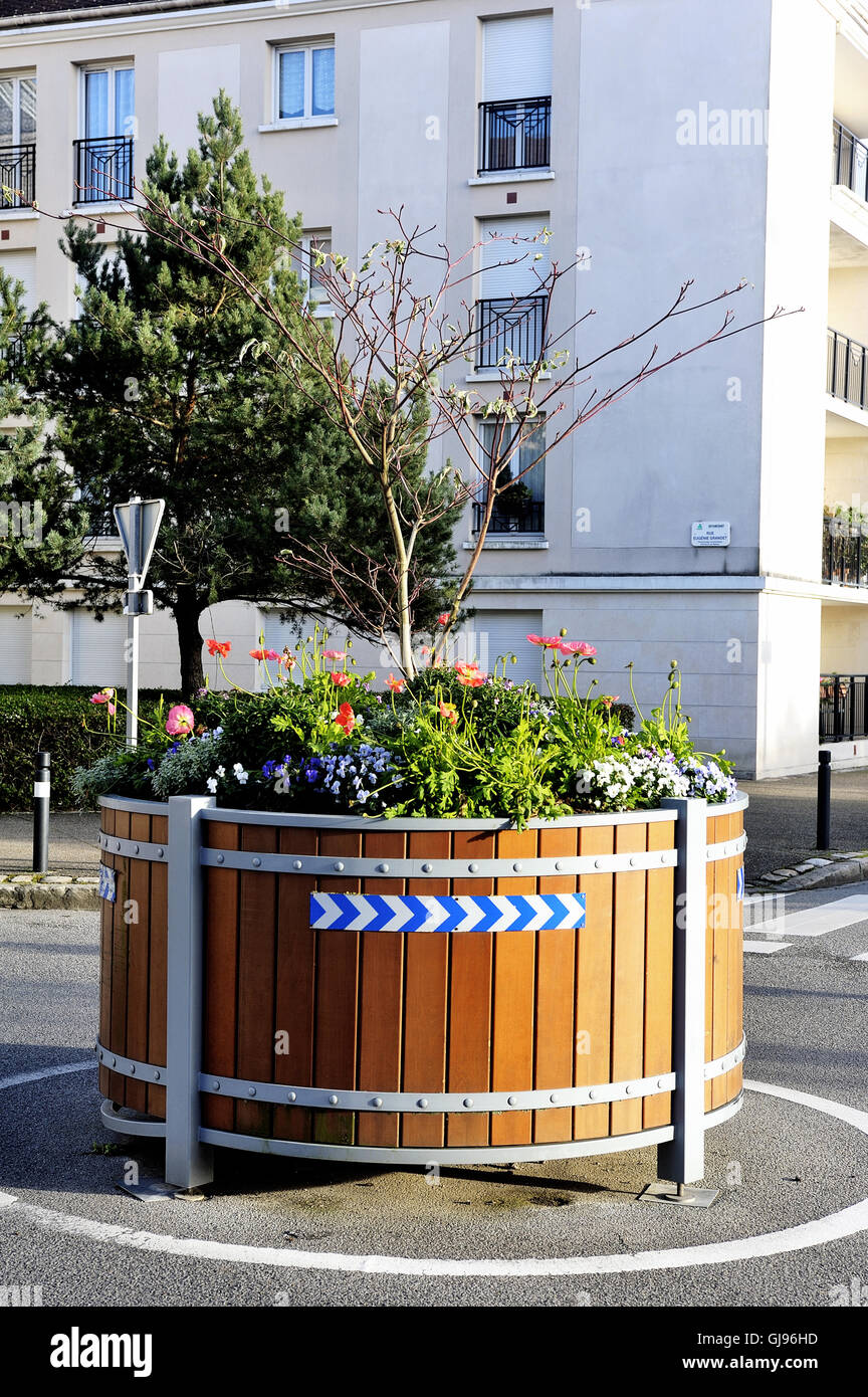 Small roundabout decorated with flowers for slowing the speed of the ...