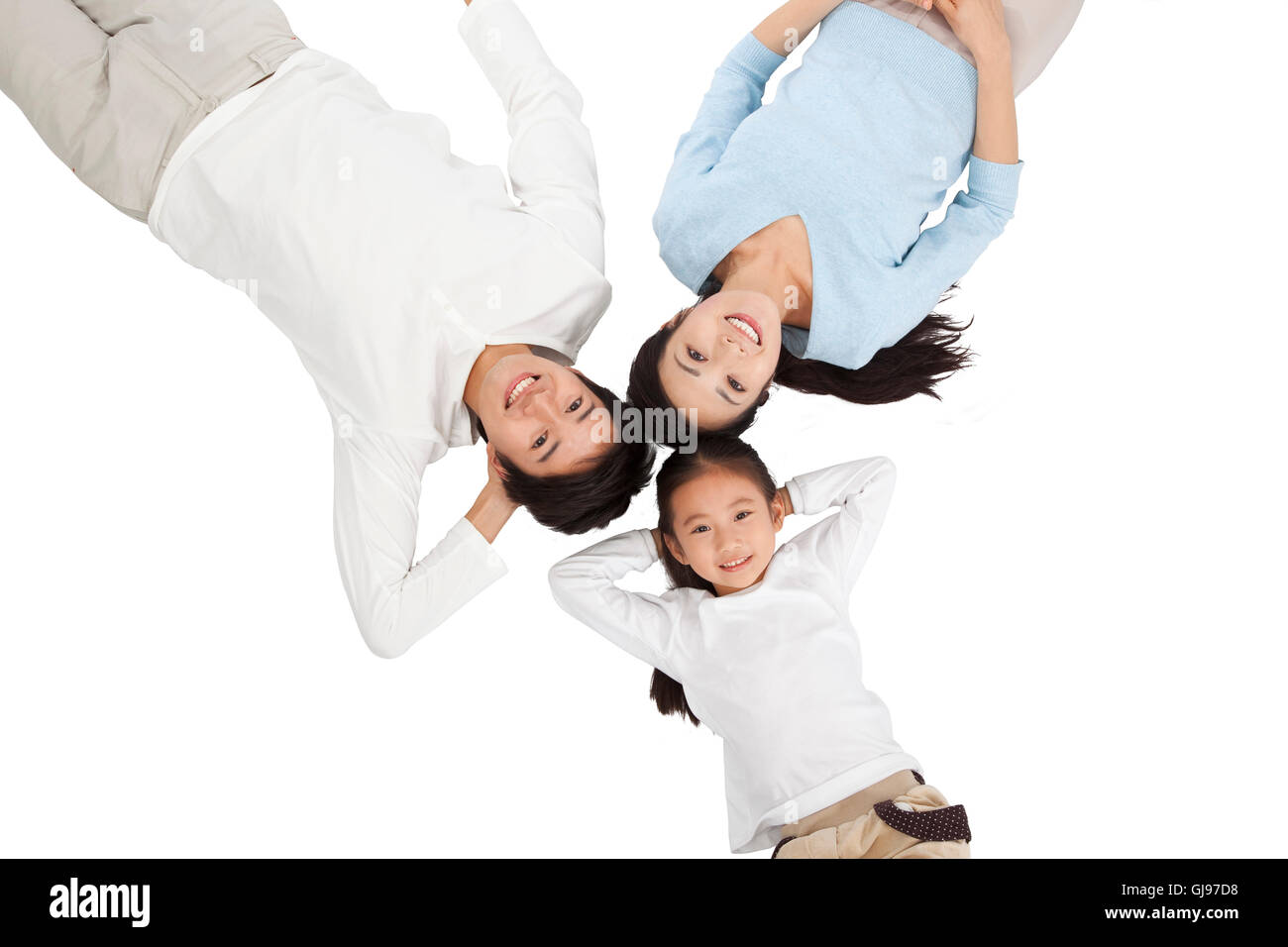 Studio shot casual family of three lay to rest Stock Photo - Alamy