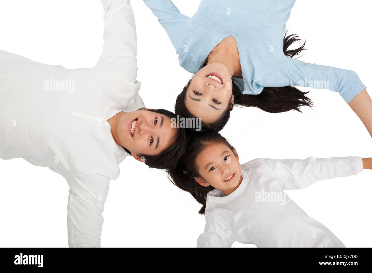Studio shot casual family of three lay to rest Stock Photo - Alamy