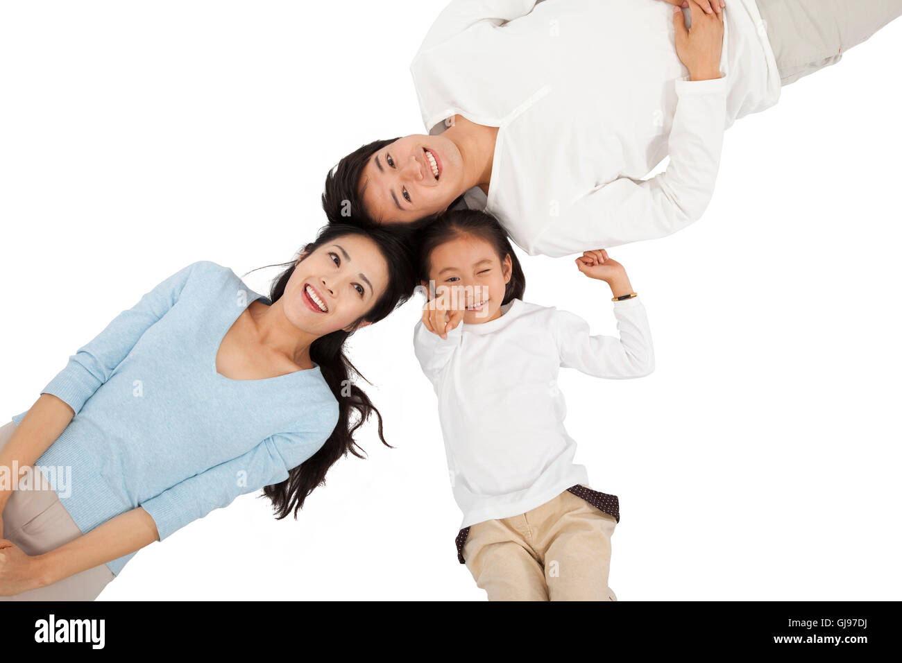 Studio shot casual family of three lay to rest Stock Photo - Alamy