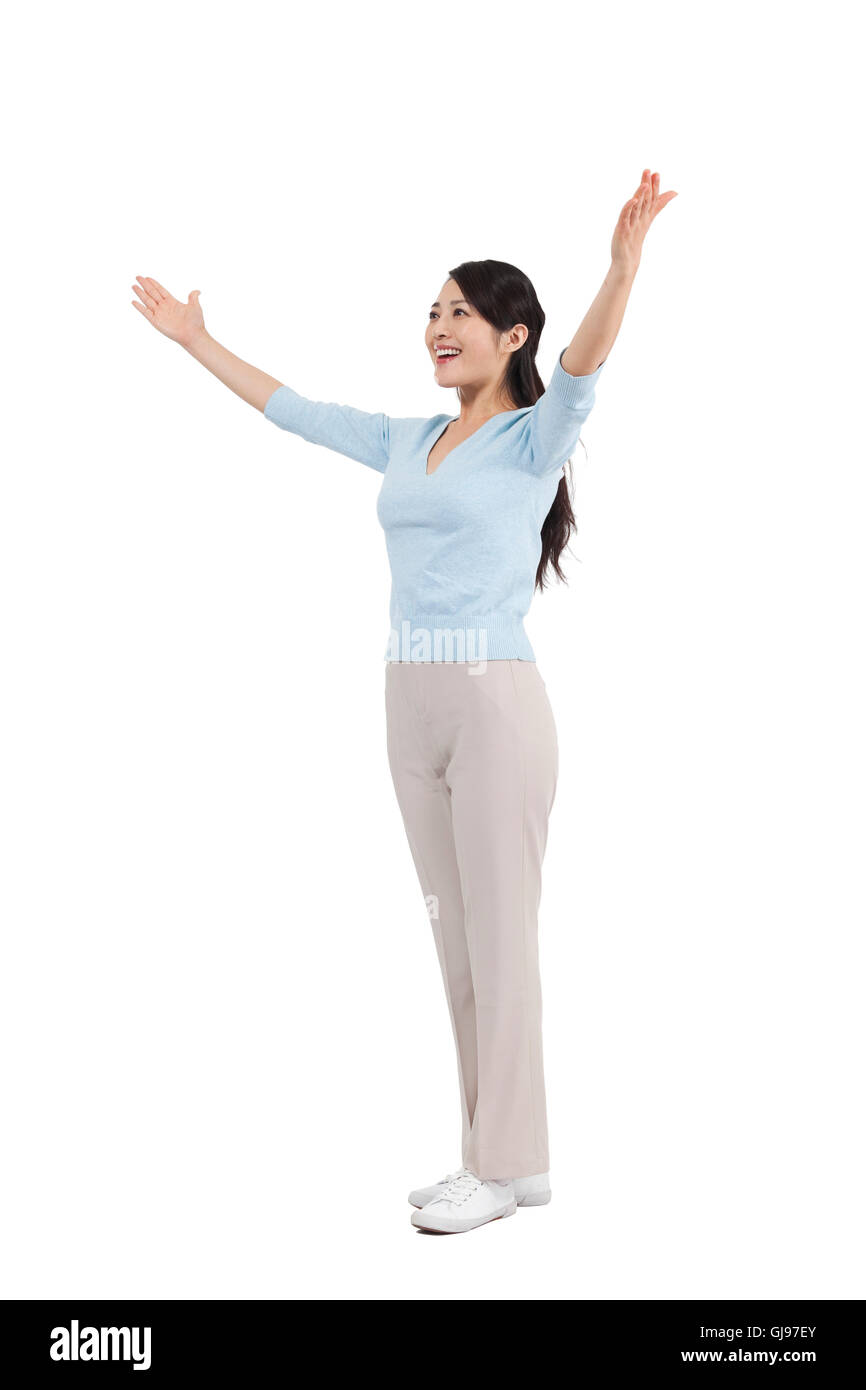 Studio shot Young casual woman with open arms Stock Photo - Alamy