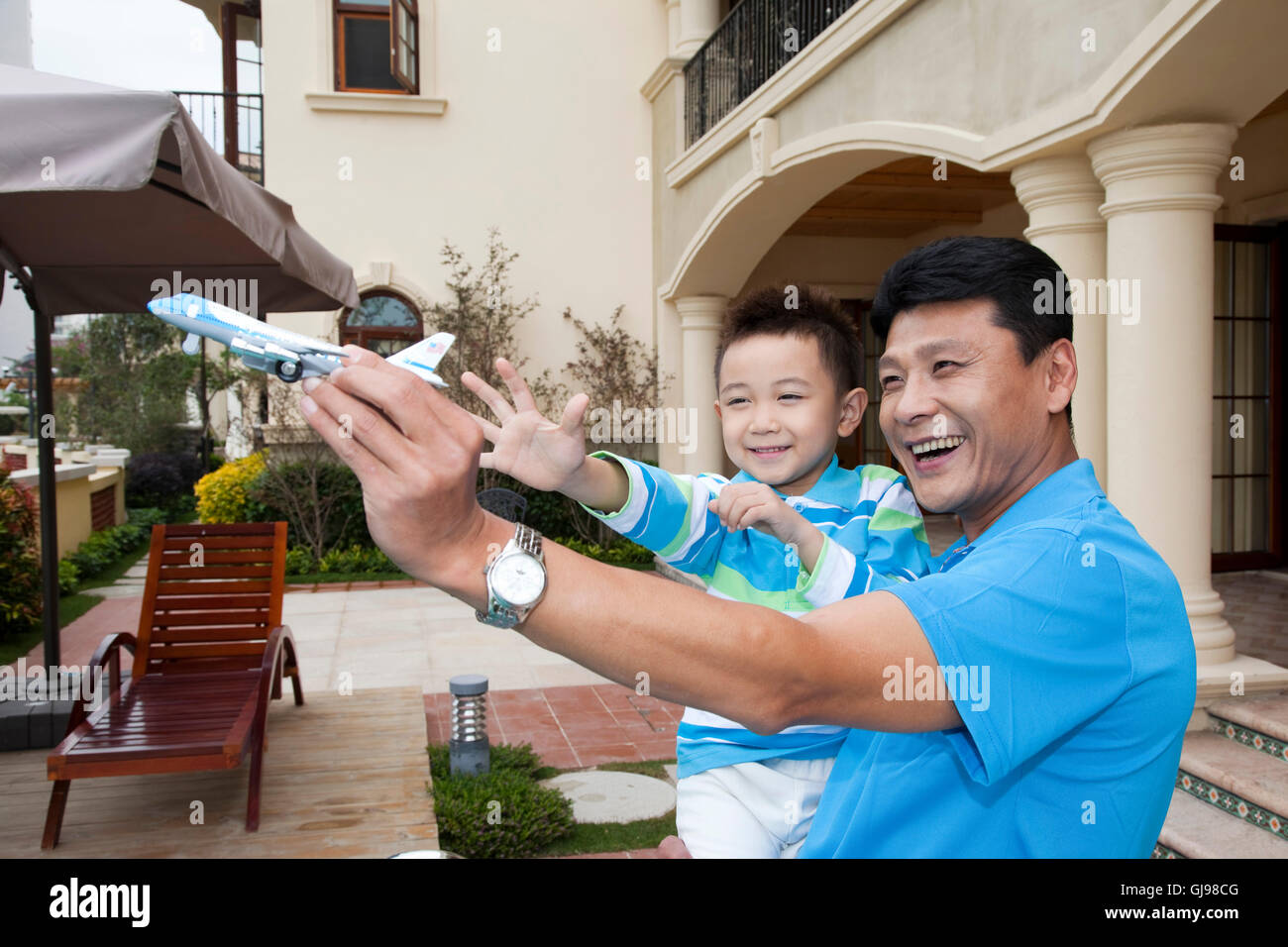 Middle-aged man and a young boy in the Hotel Holiday Stock Photo - Alamy