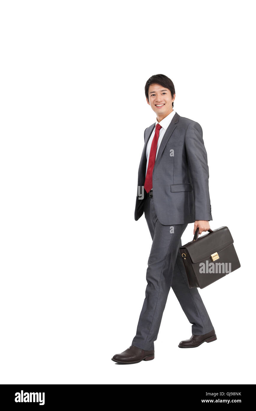 Studio shot business attire Young men carry a briefcase walking Stock ...