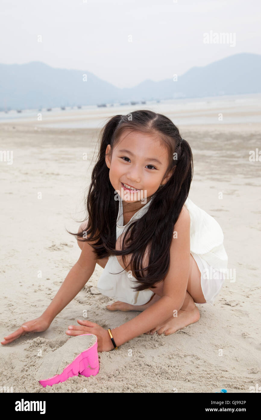 The little girl playing on the beach Stock Photo - Alamy