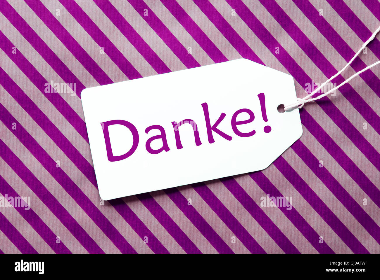 Label On Purple Wrapping Paper, Danke Means Thank You Stock Photo - Alamy
