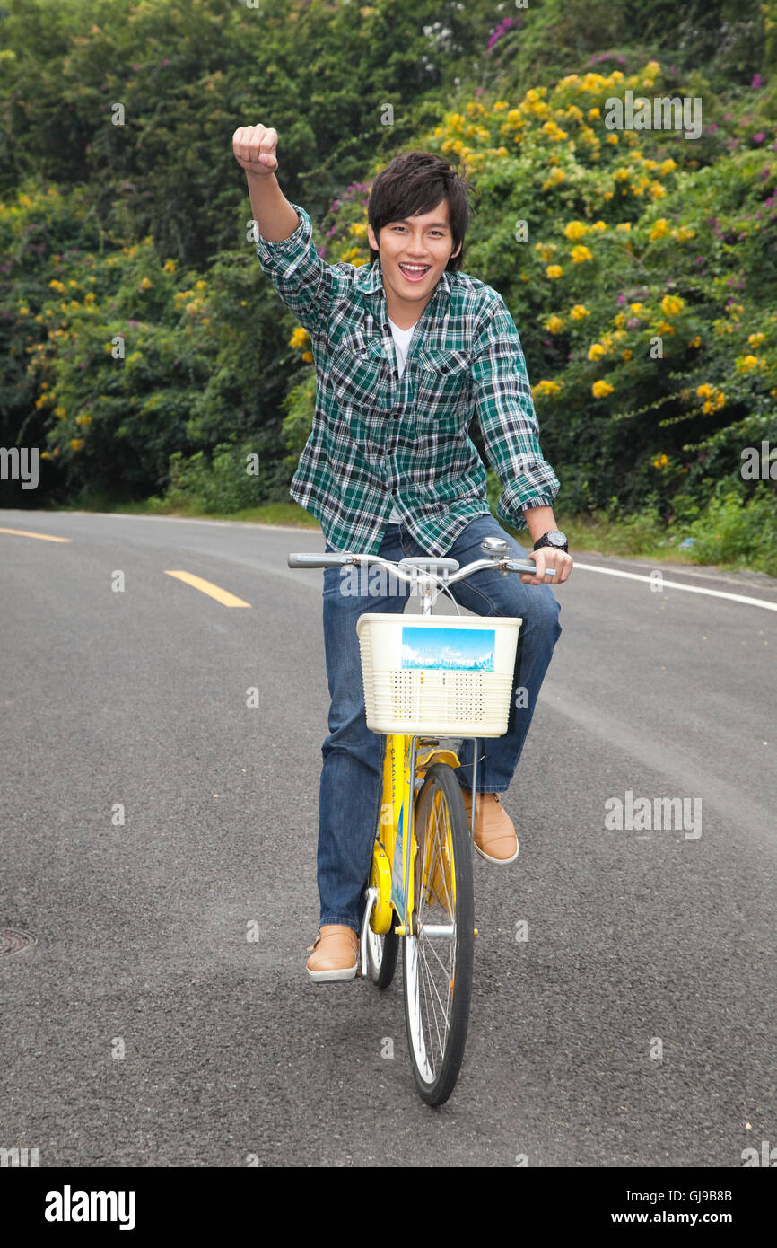 A young male college student on campus cycling Stock Photo - Alamy
