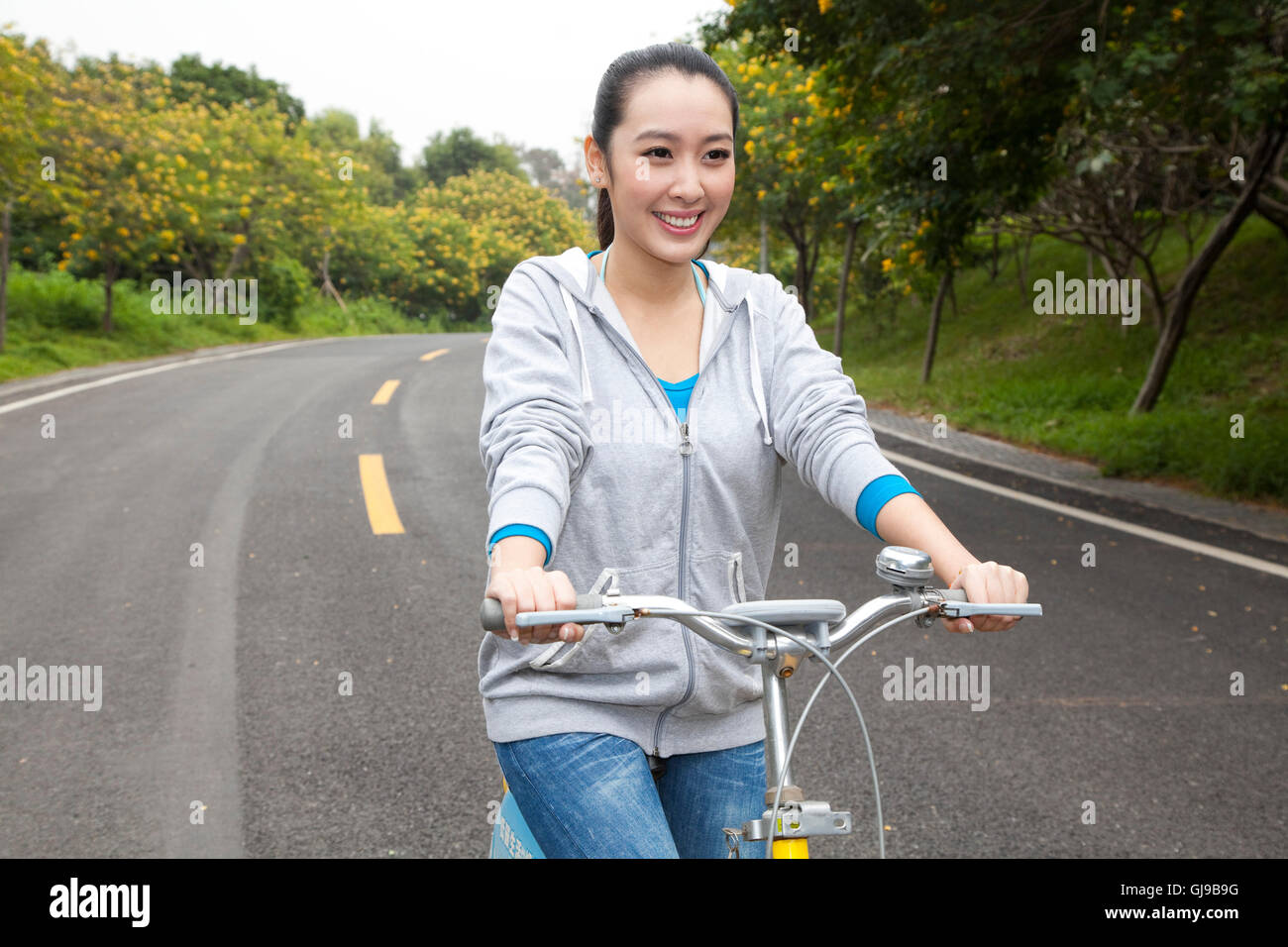 A young female students on campus cycling Stock Photo - Alamy