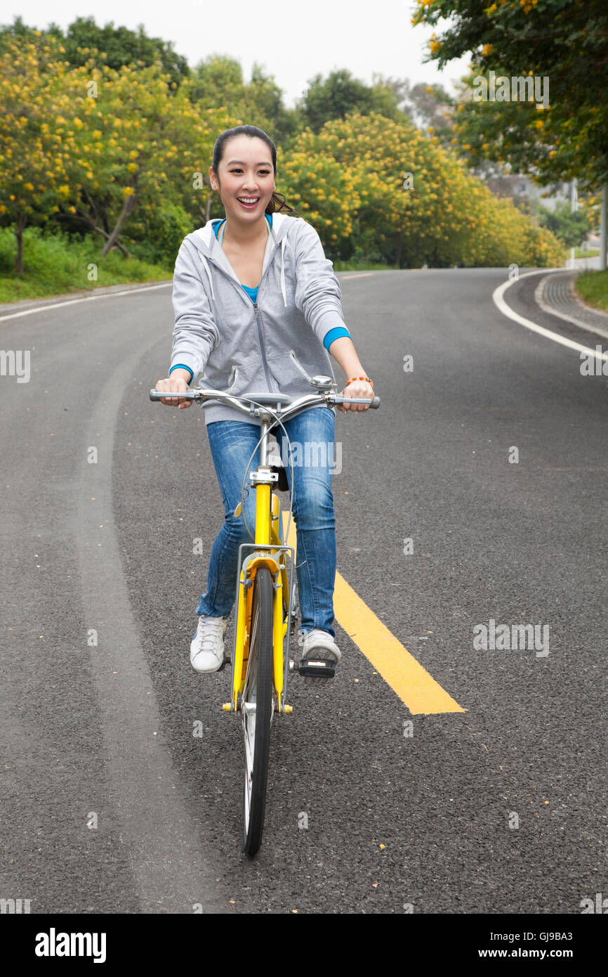 A young female students on campus cycling Stock Photo - Alamy