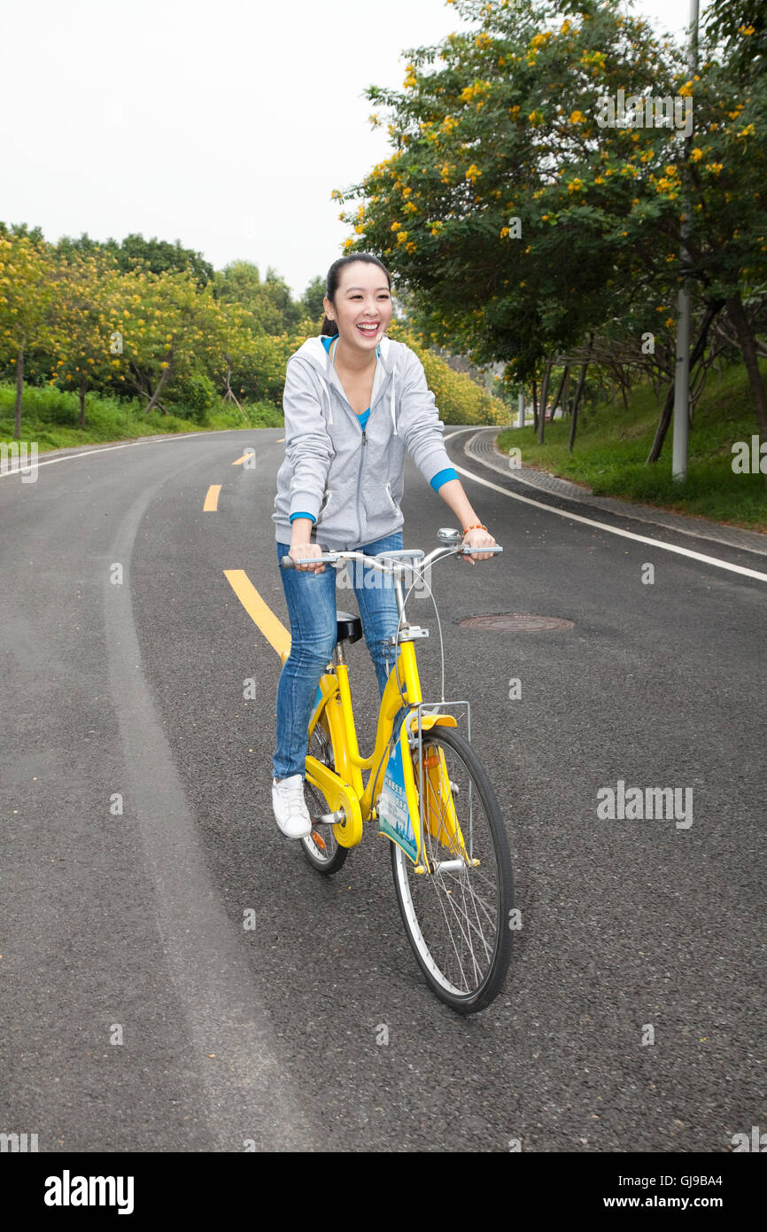 A young female students on campus cycling Stock Photo - Alamy