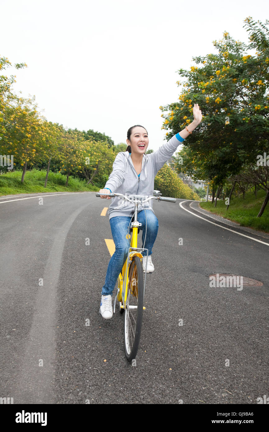 A young female students on campus cycling Stock Photo - Alamy