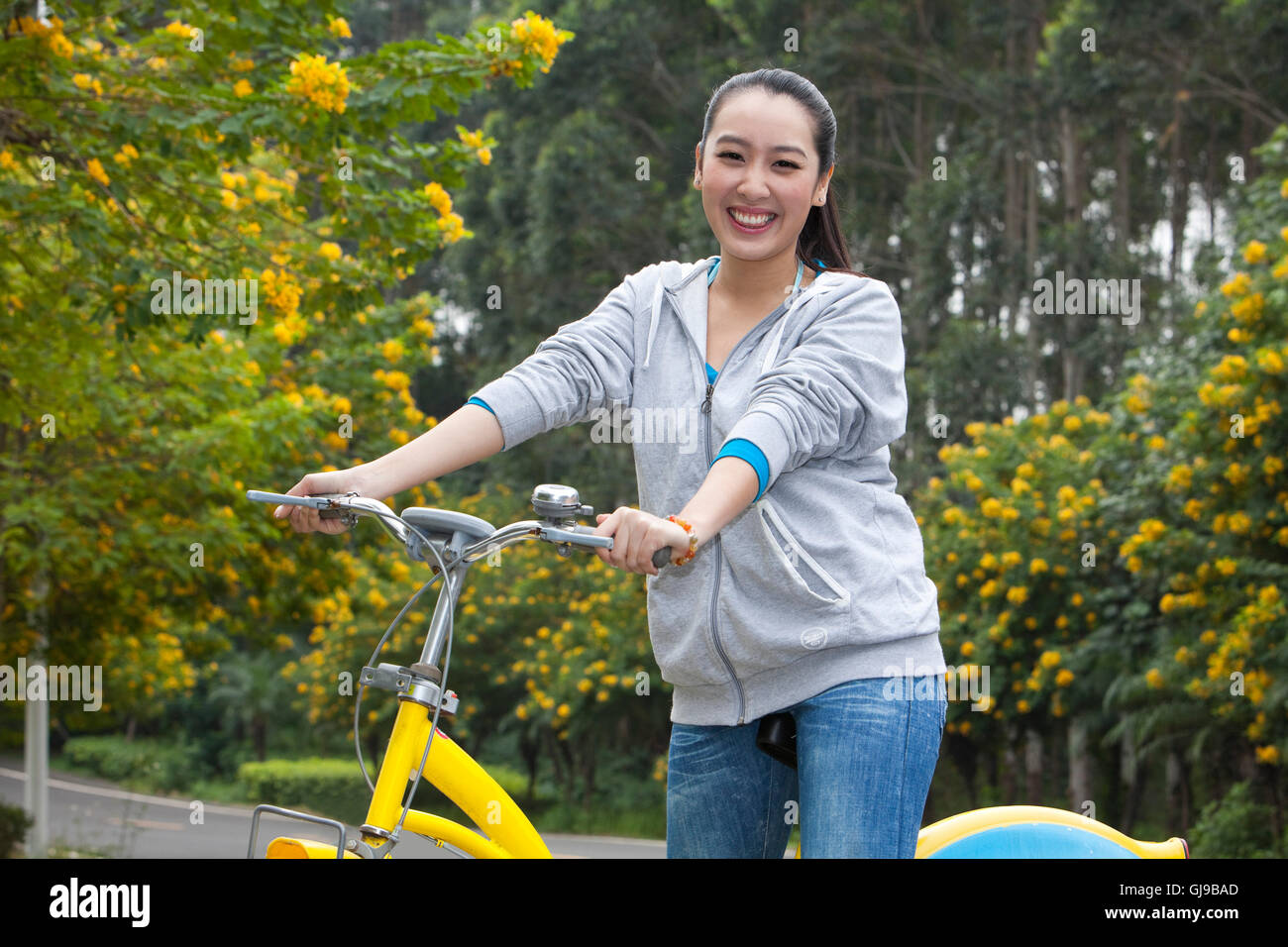 A young female students on campus cycling Stock Photo - Alamy