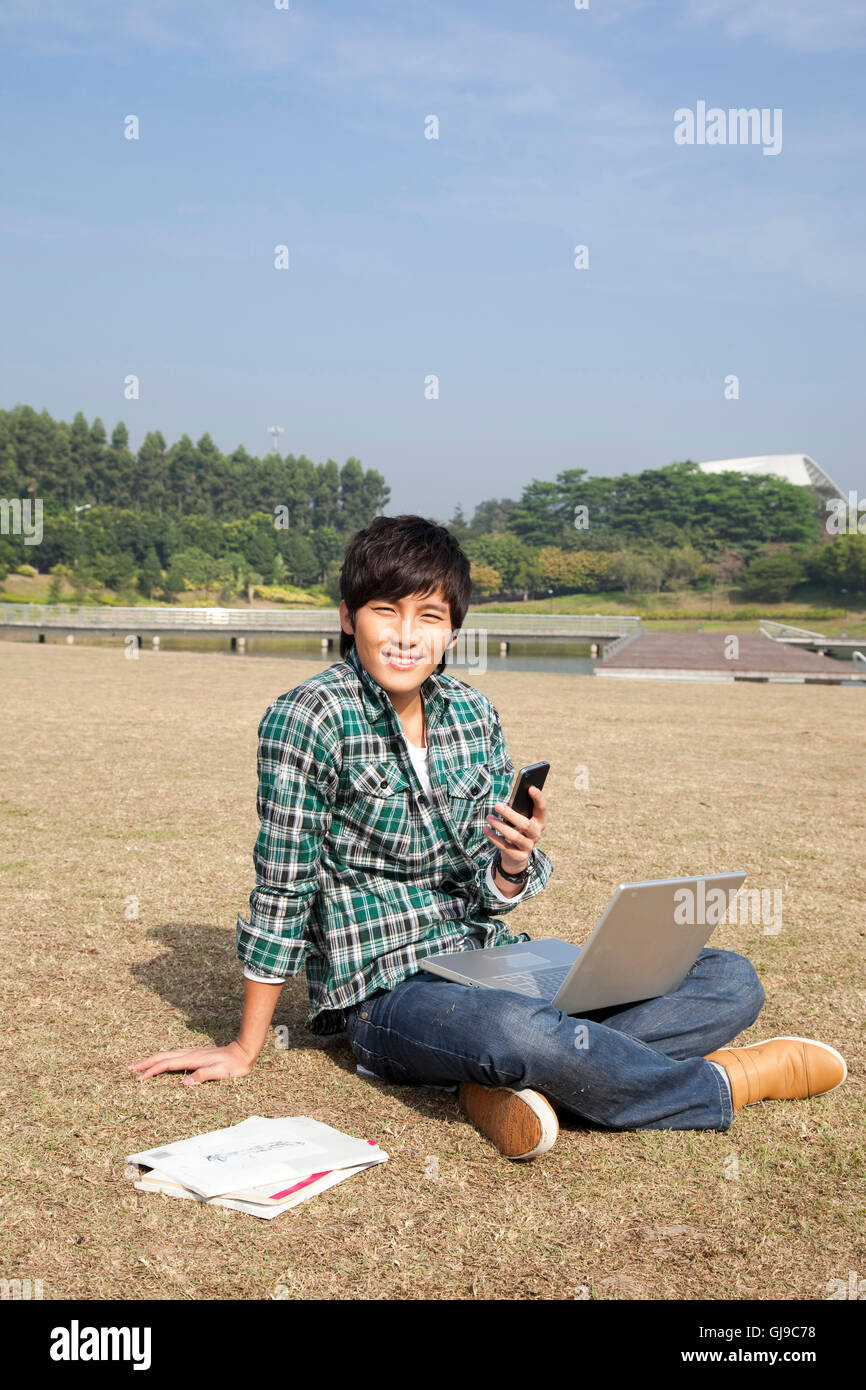 Young college students in a park outing Stock Photo - Alamy