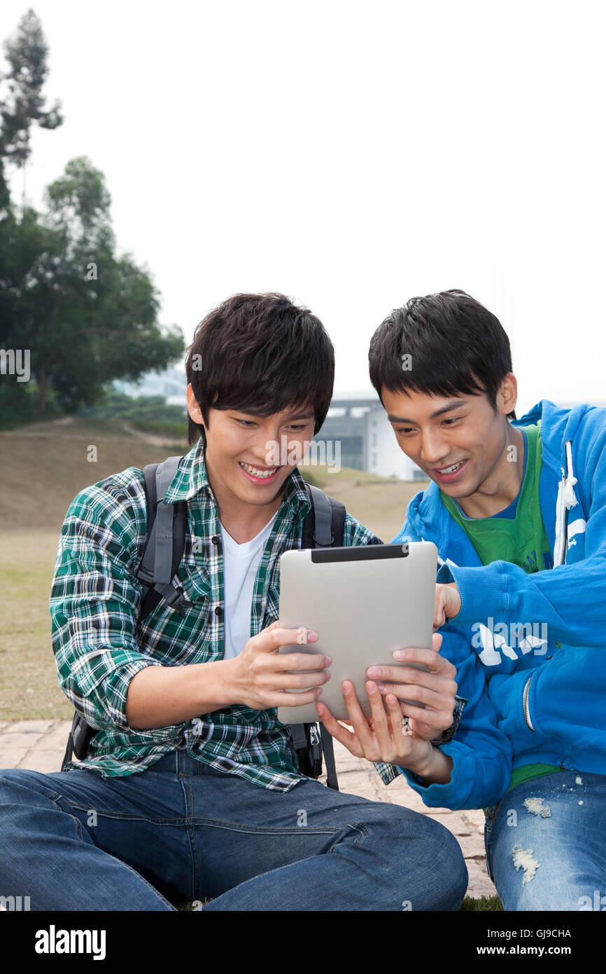 Young college students in a park outing Stock Photo - Alamy