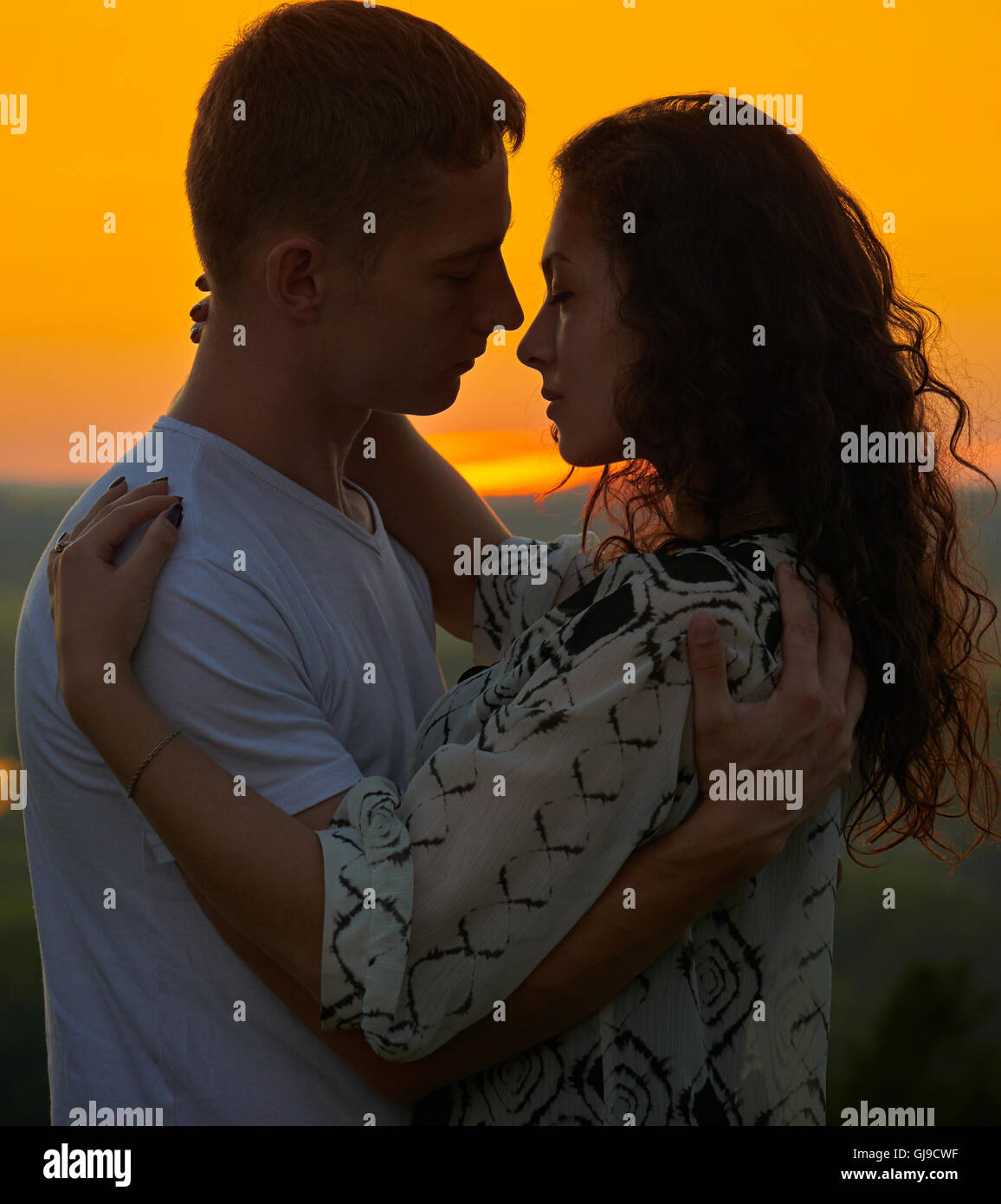 romantic couple embrace at sunset on outdoor, beautiful landscape and ...