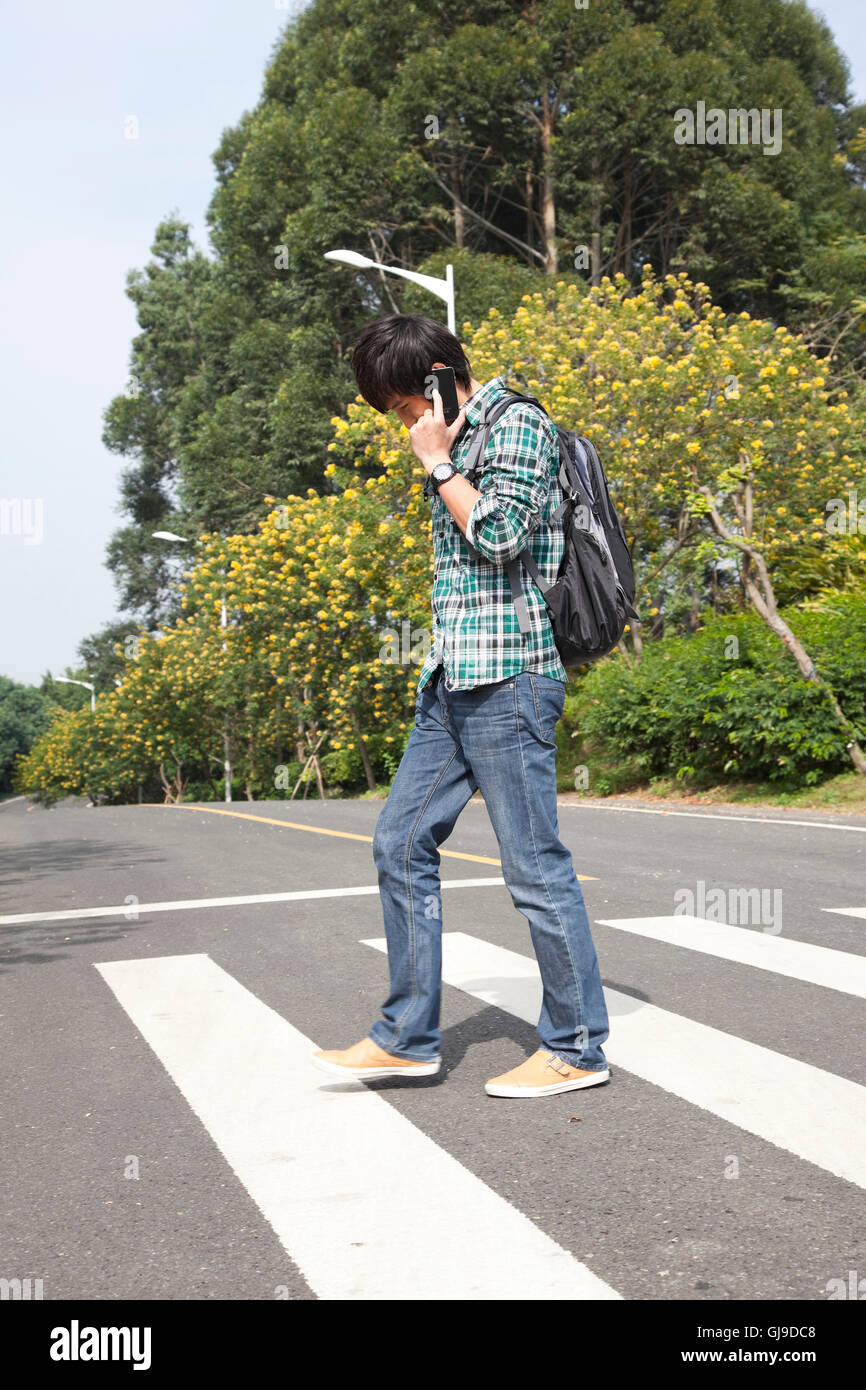 Young college students crossing the road Stock Photo - Alamy