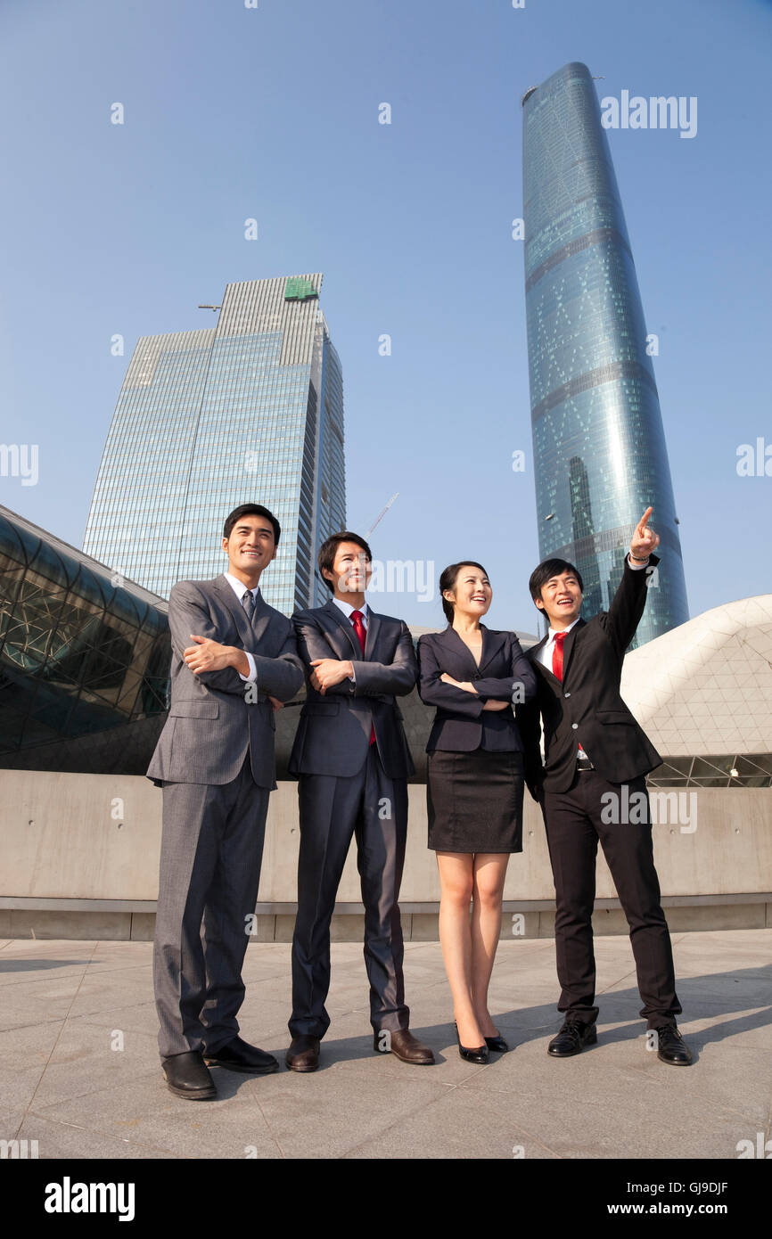 Young men and women in business outside the office building Stock Photo ...