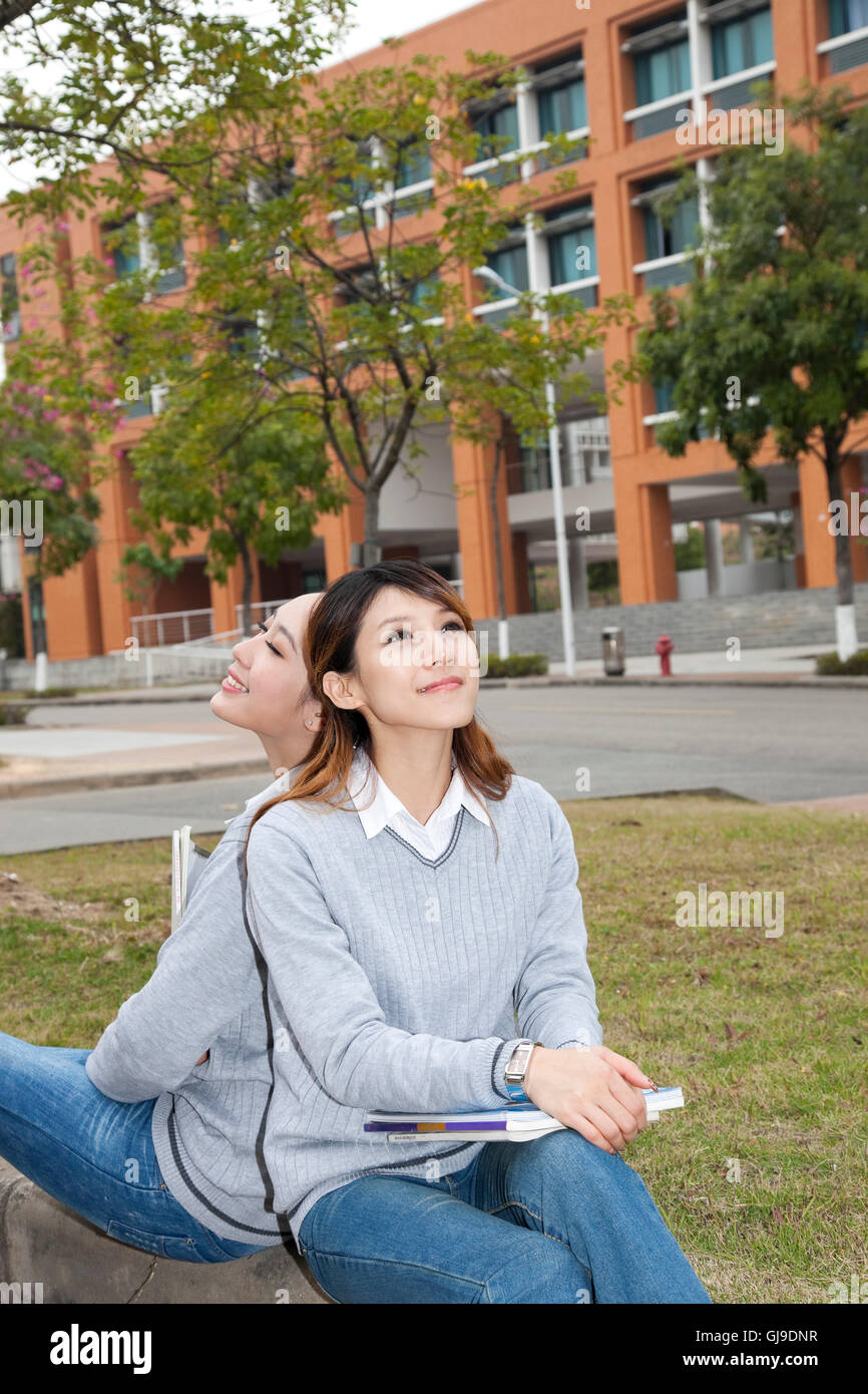Young female students on campus to rest Stock Photo - Alamy