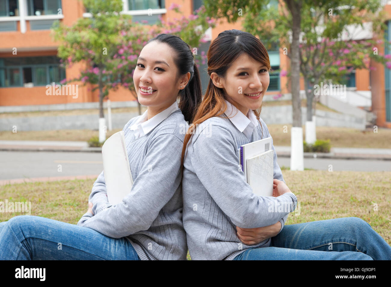 Young female students on campus to rest Stock Photo - Alamy