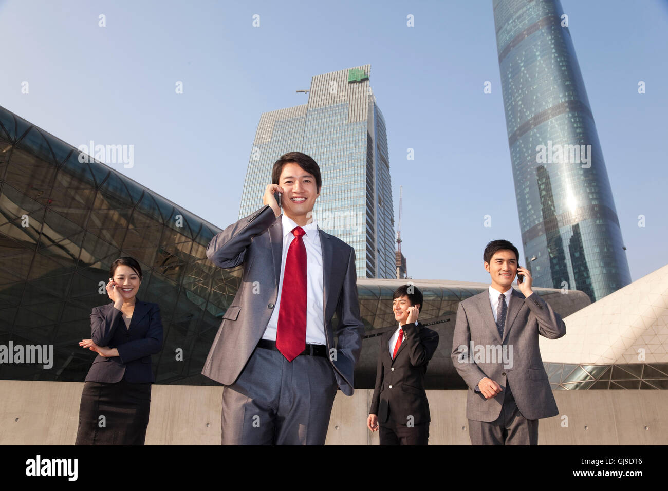 Young men and women in business outside the office building Stock Photo ...
