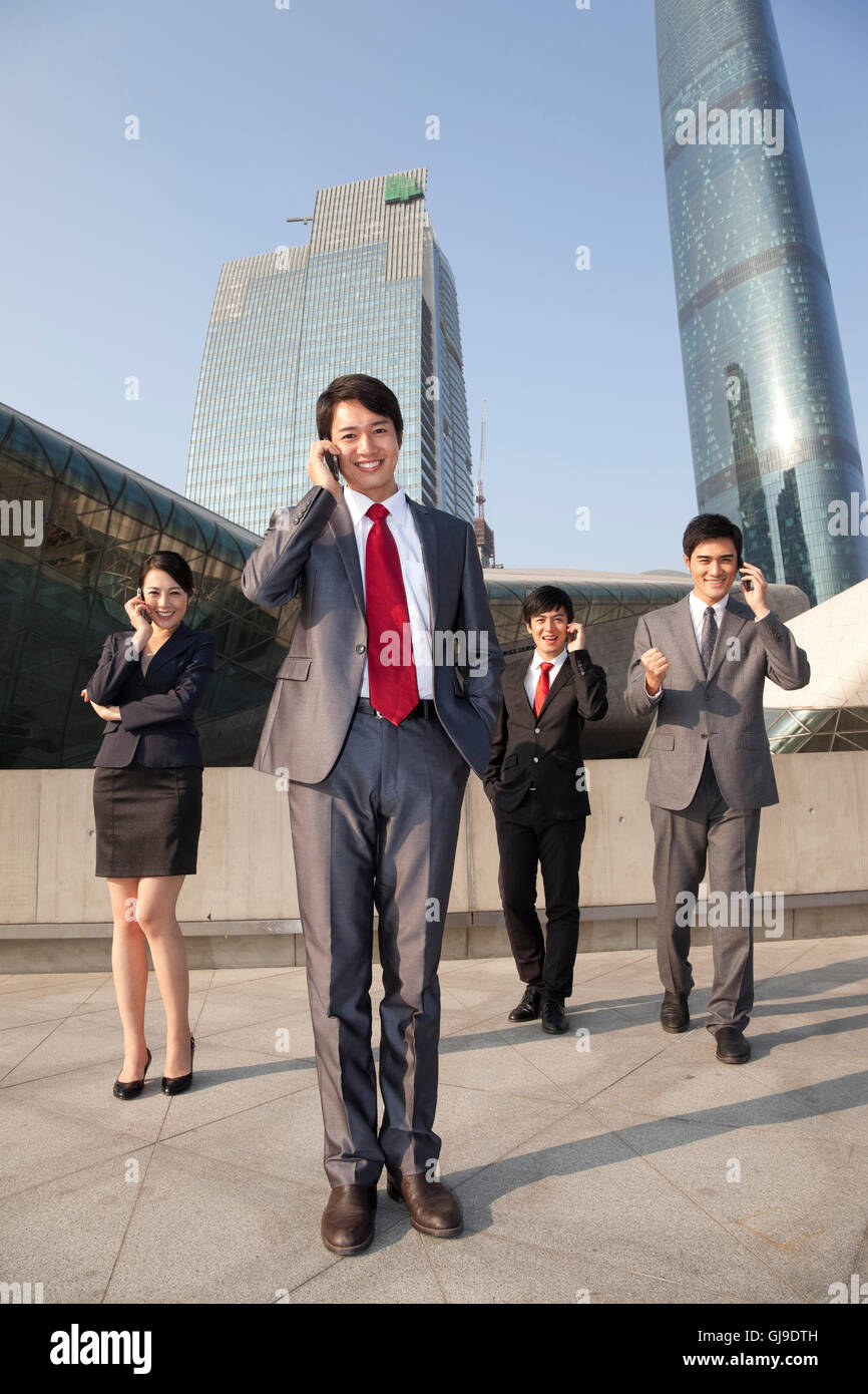 Young men and women in business outside the office building Stock Photo ...