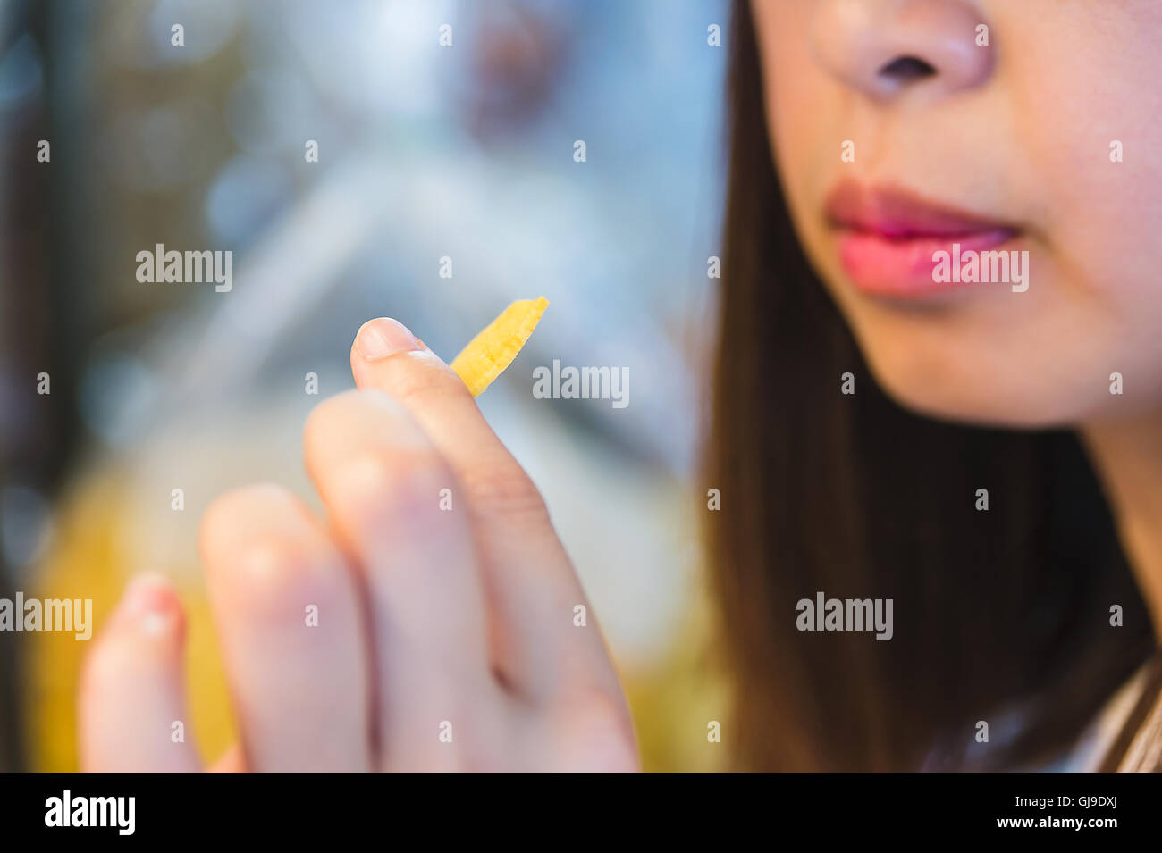 Asian woman eating snack, lifestyle concept Stock Photo - Alamy