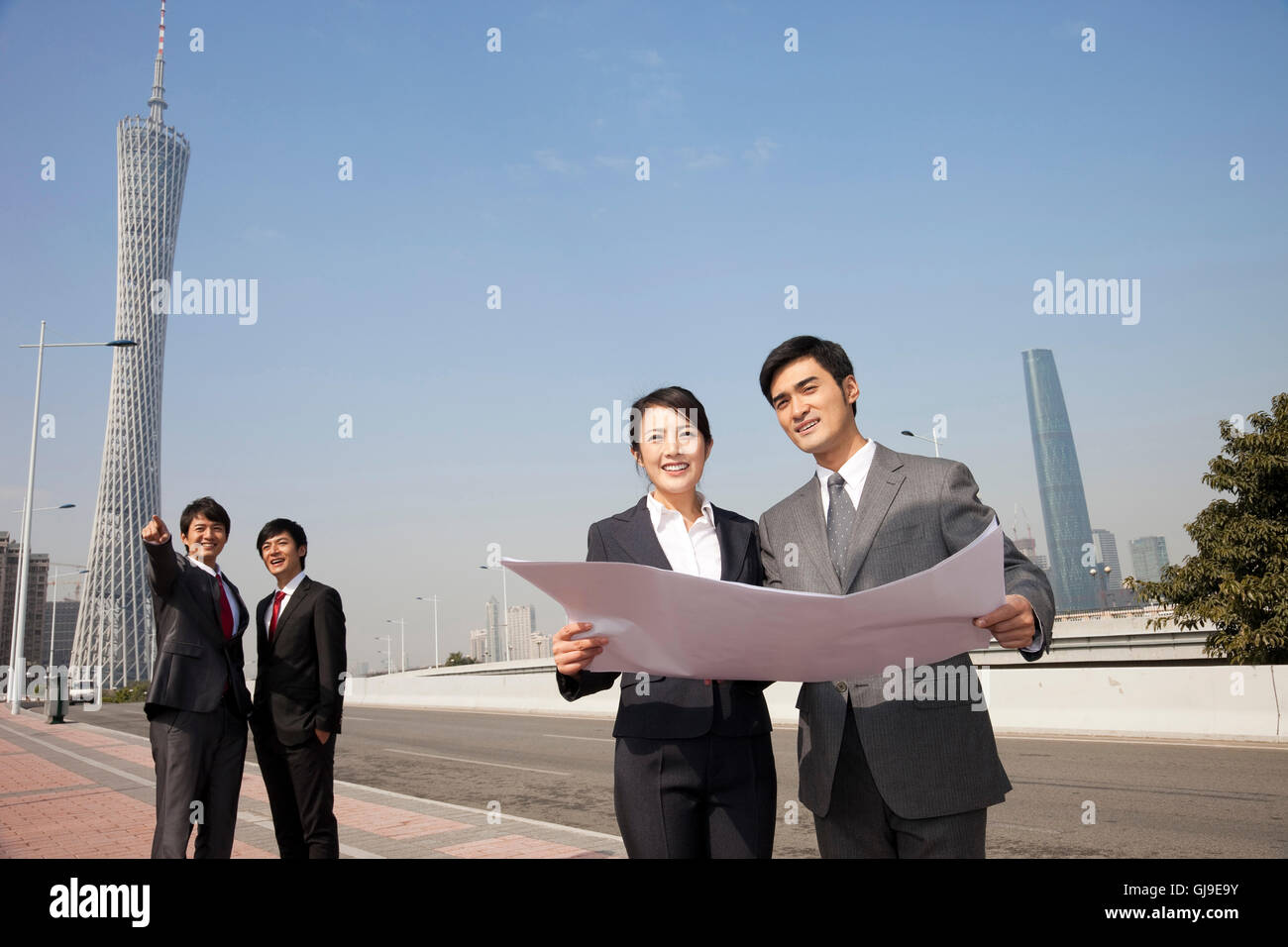 Young business men and ladies in business outside the office building ...