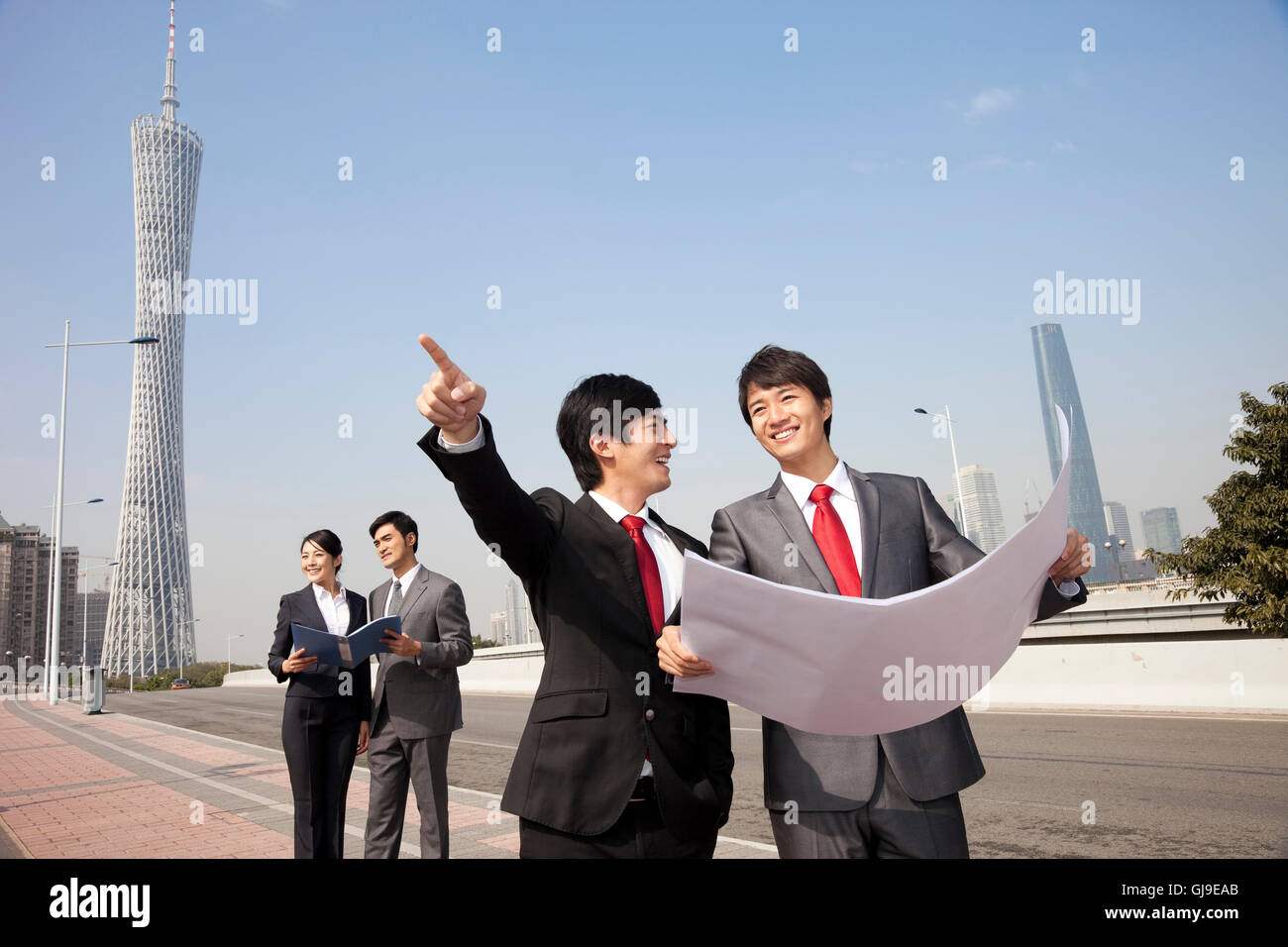 Young business men and ladies in business outside the office building ...