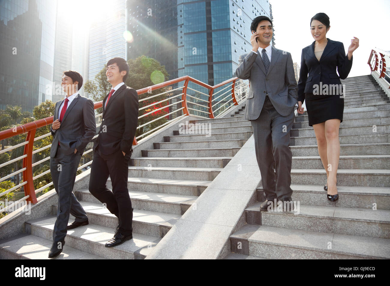 Young business men and ladies in business outside the office building ...