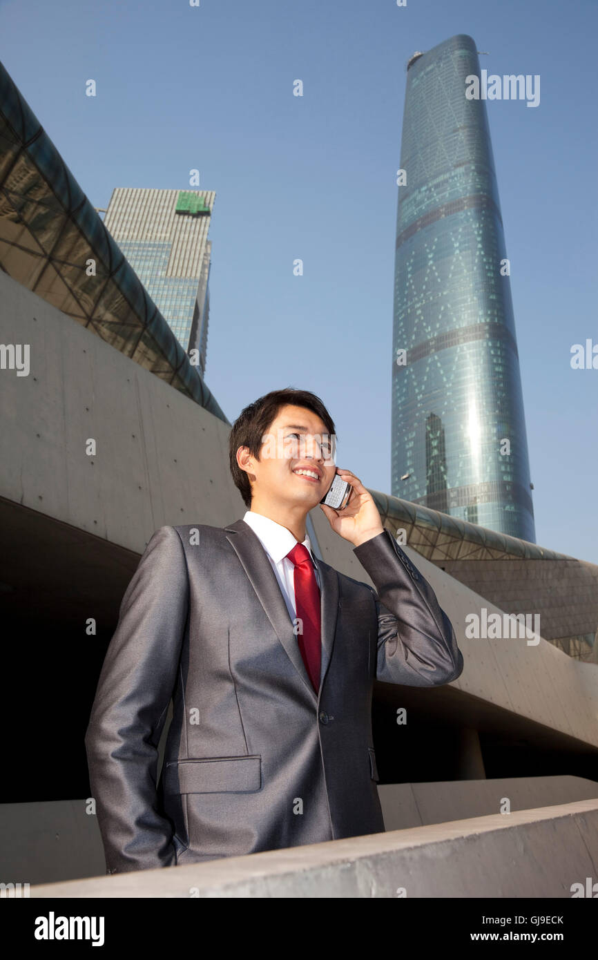 Young business man outside office building Stock Photo - Alamy